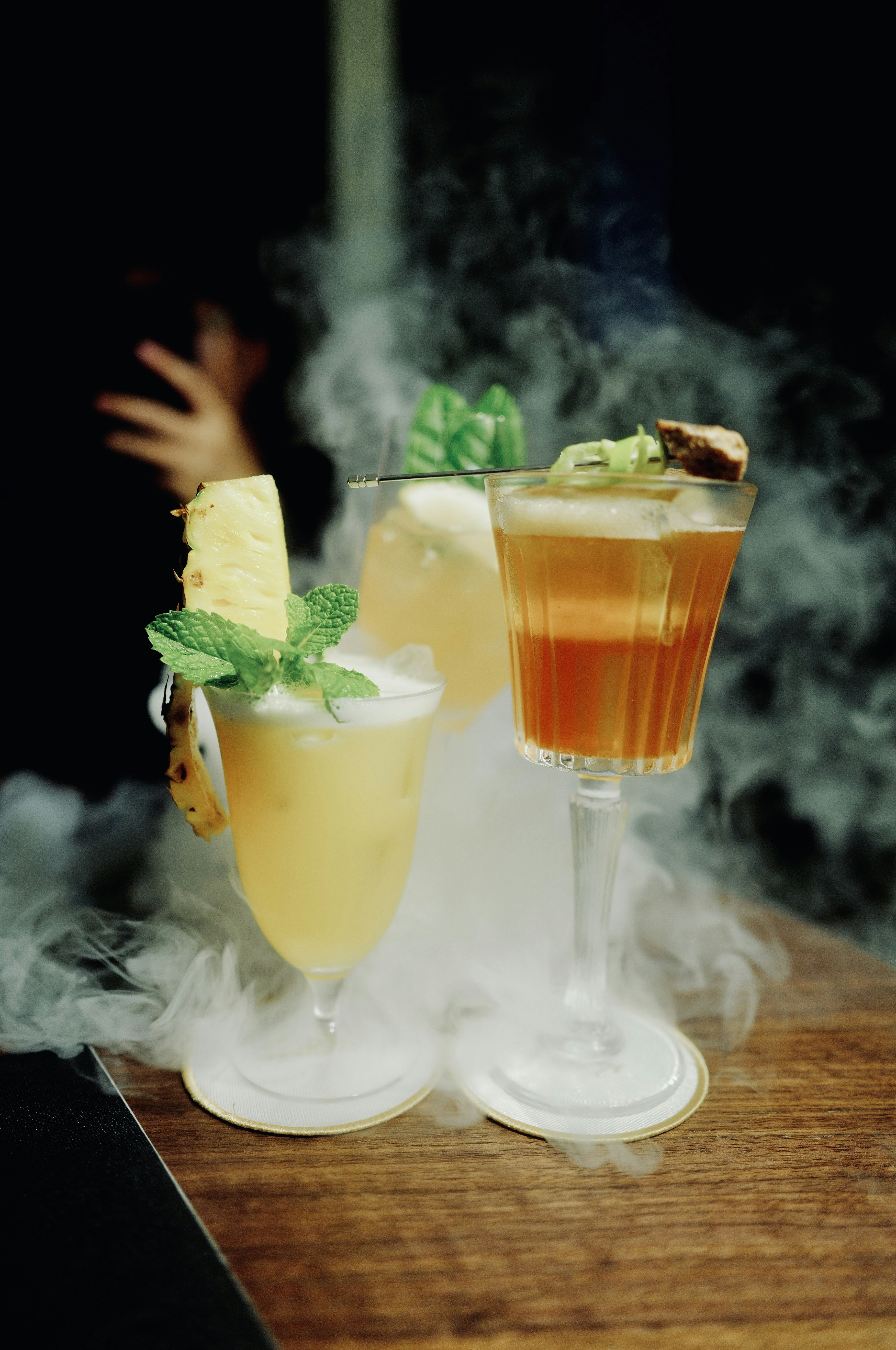 Smoke-Kissed Libations: Pineapple, Mint, and Amber in a Dim Bar Portrait
