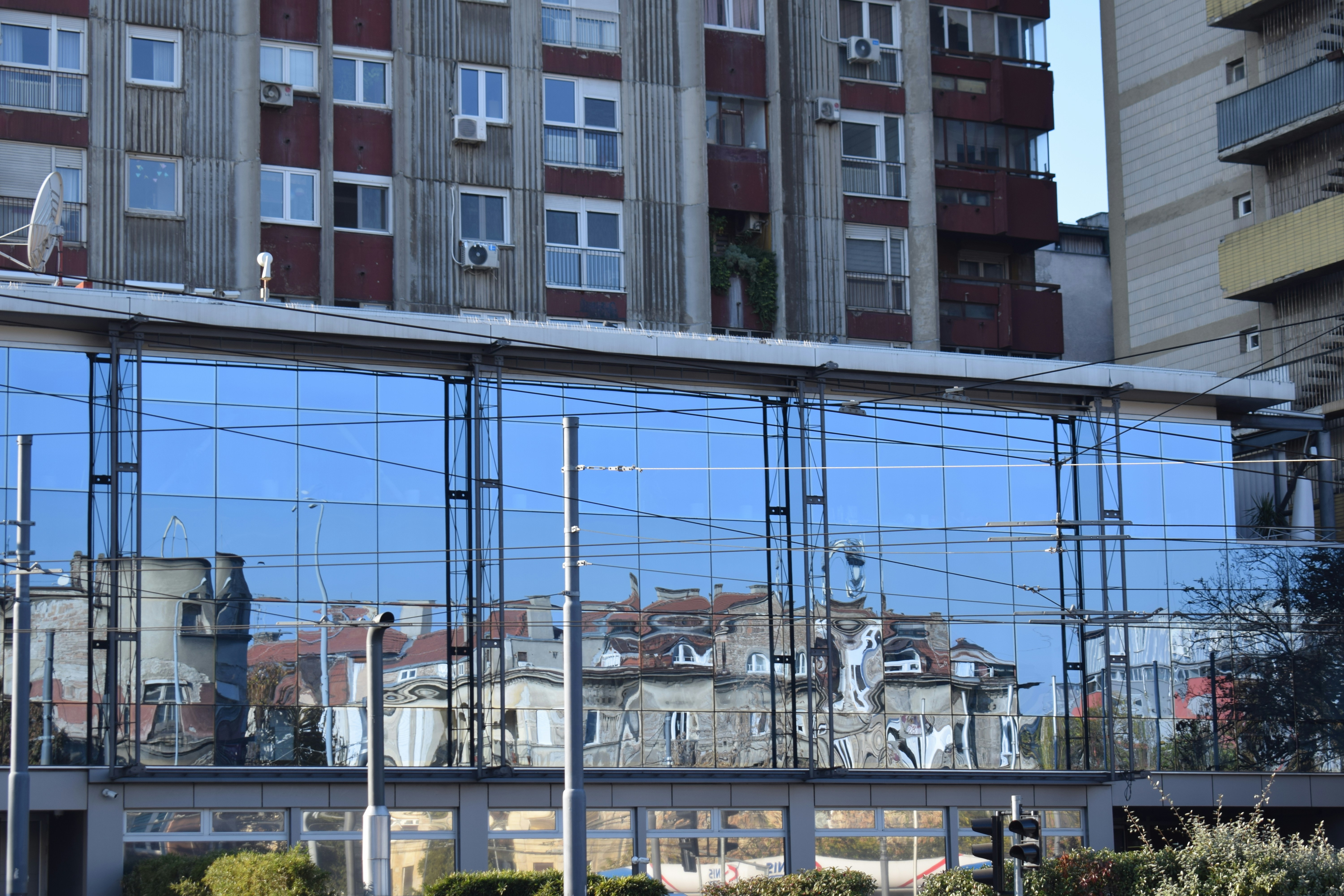 Reflection Mosaic: City Blocks Align in a Glass Atrium