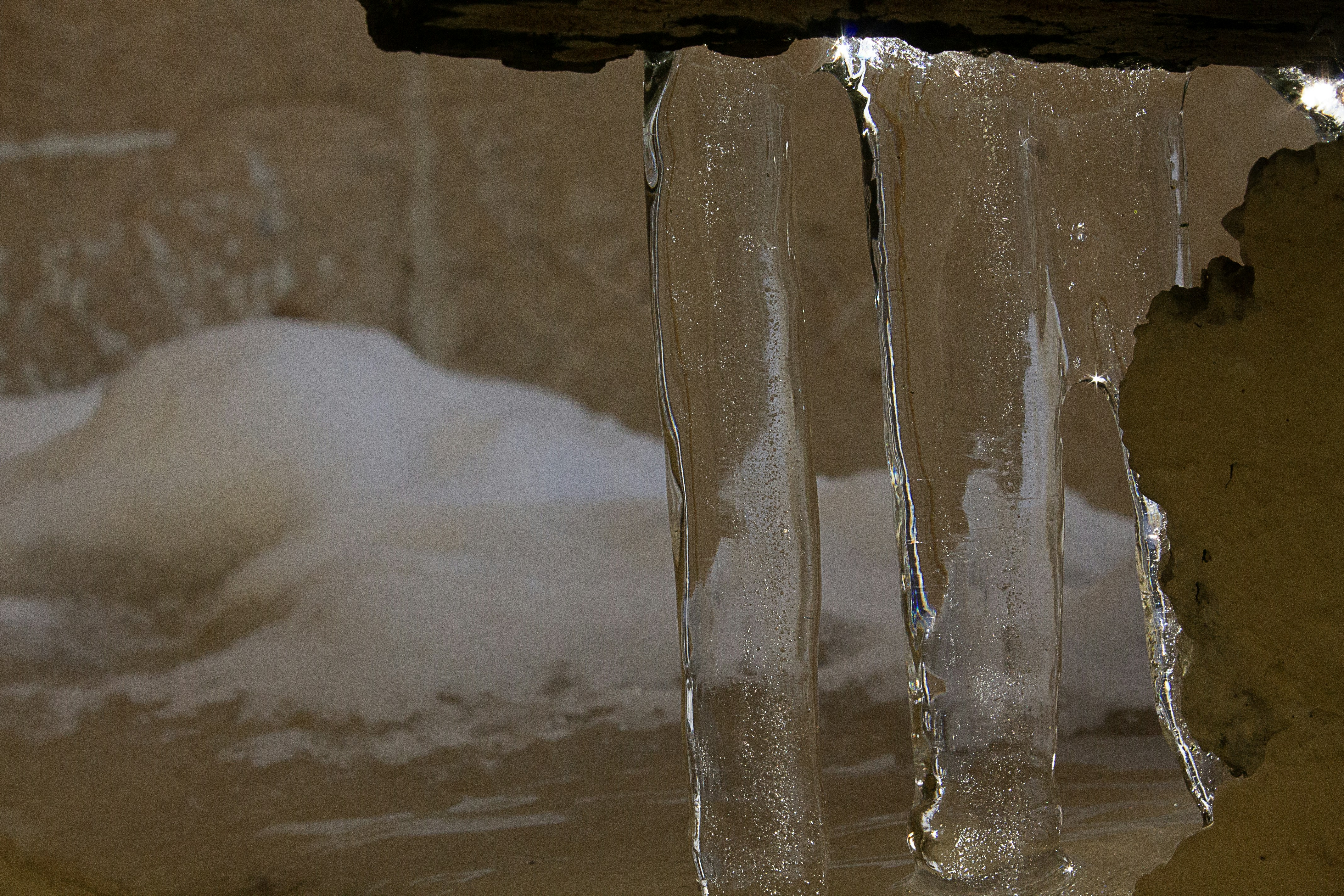 Crystal Icicles Framed by a Snow-Dusted Wall