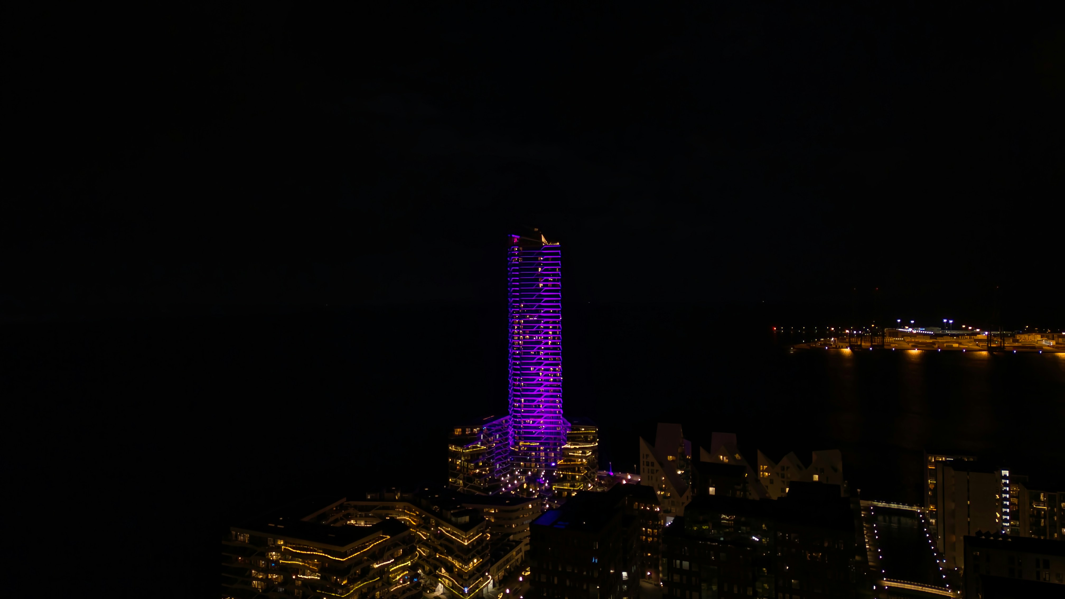 A purple tower lit up in the night sky photo – Free City Image on Unsplash