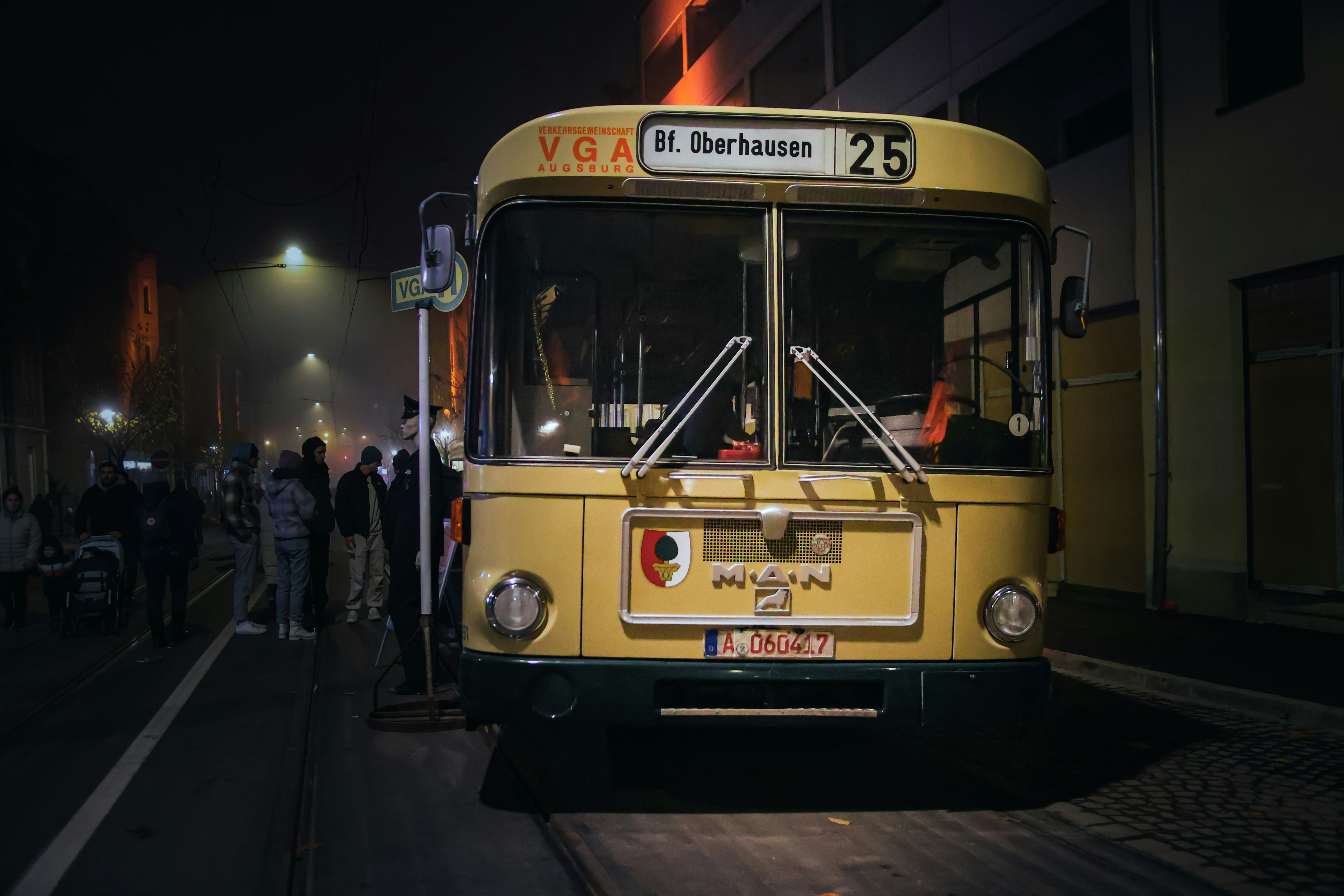 Amber-Lit Retro Bus: Night on a Cobblestone Street