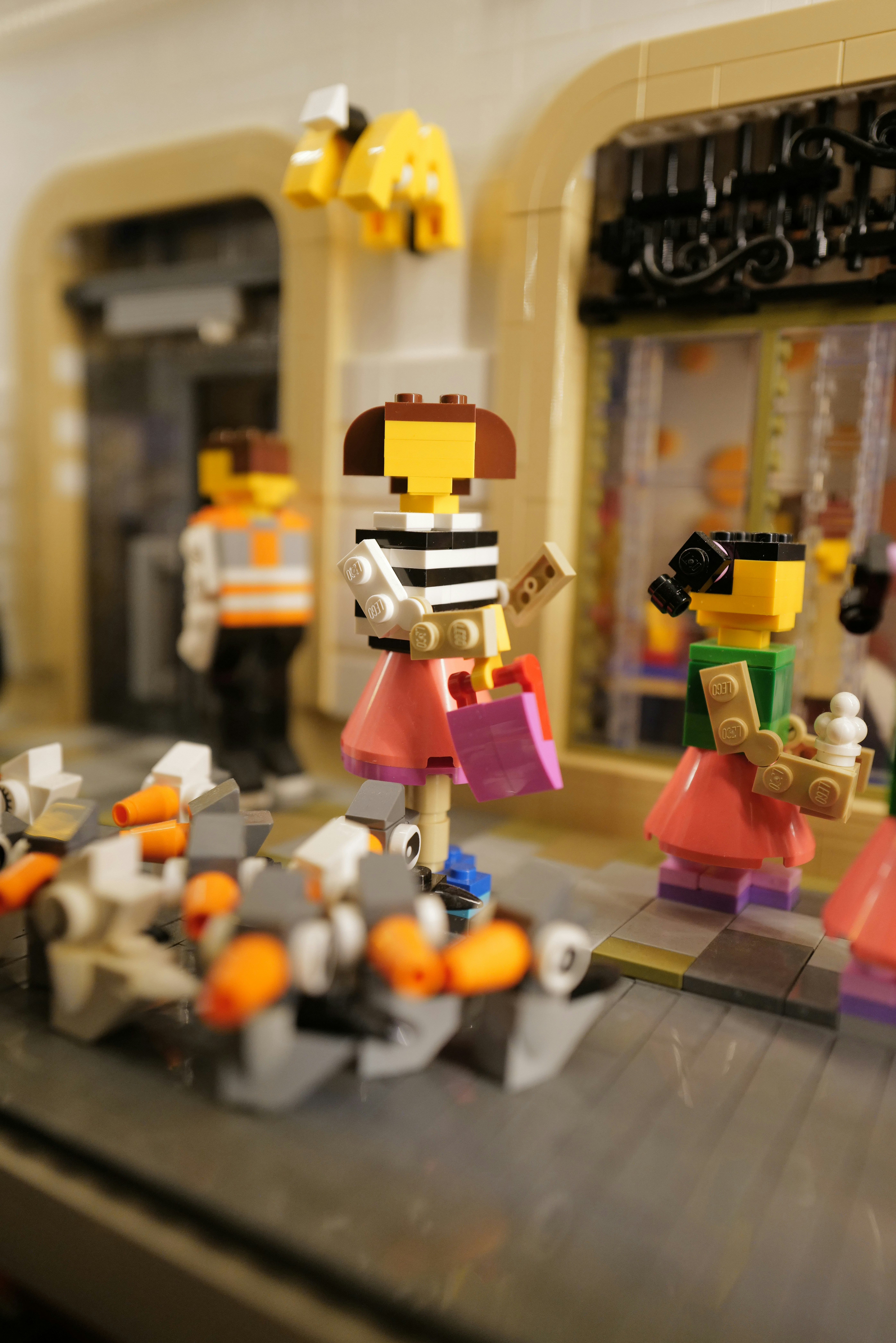 Brick Street Scene: Striped Figure Among Pink-Skirt Shoppers