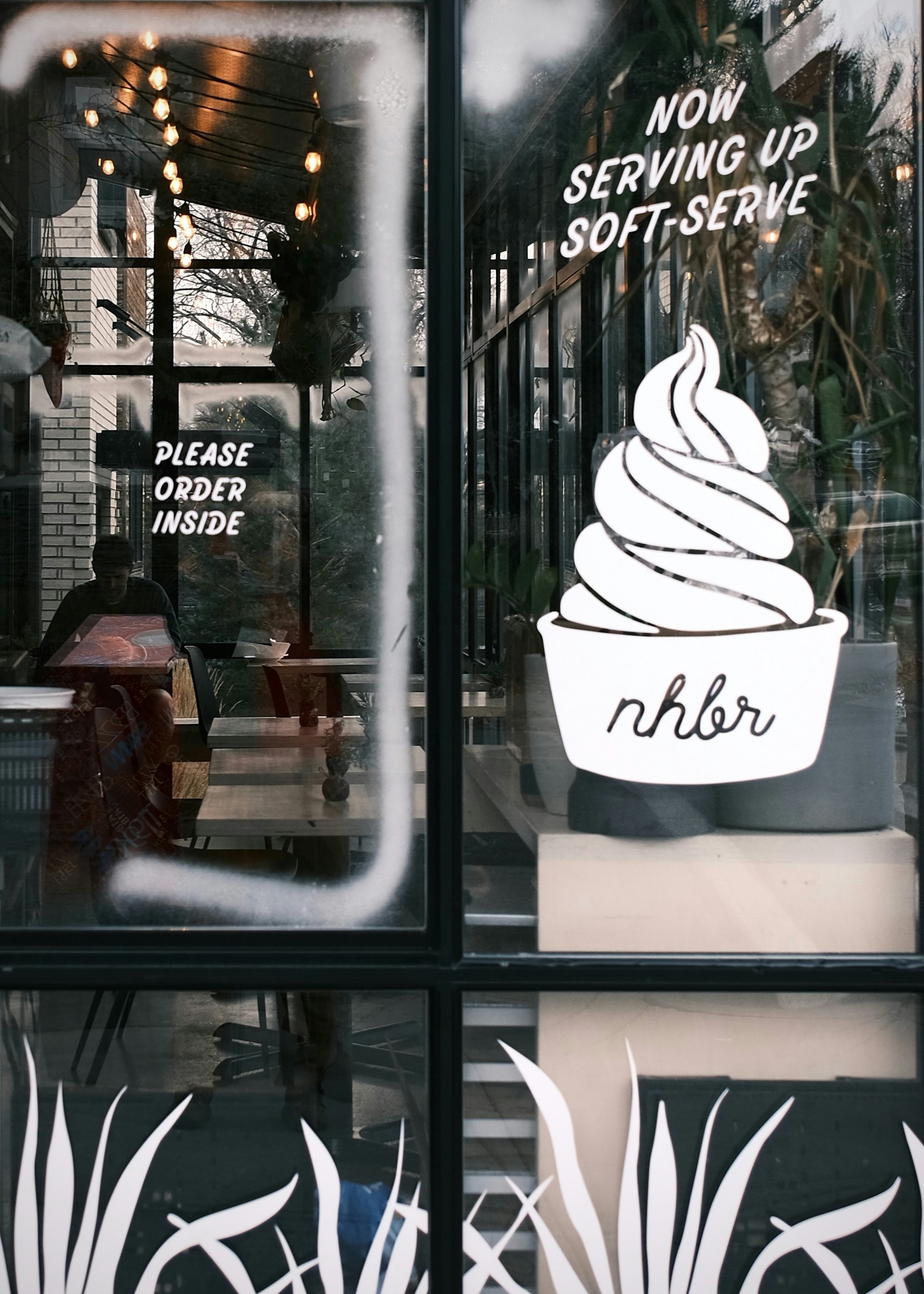 Soft-Serve Emblem Framed by Window Grids and Reflections