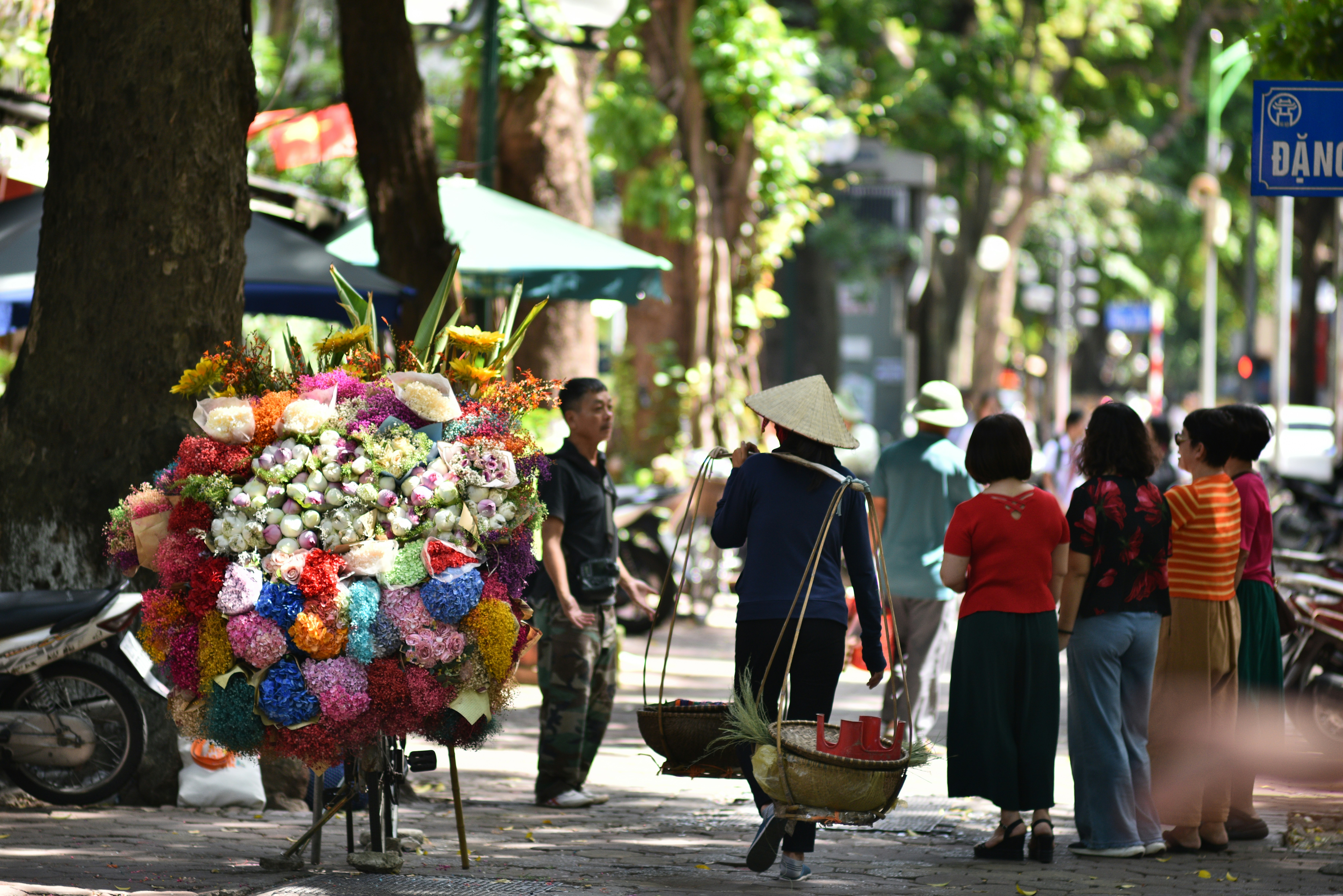 Sunlit Flower Cart: Color Burst on a Busy Street