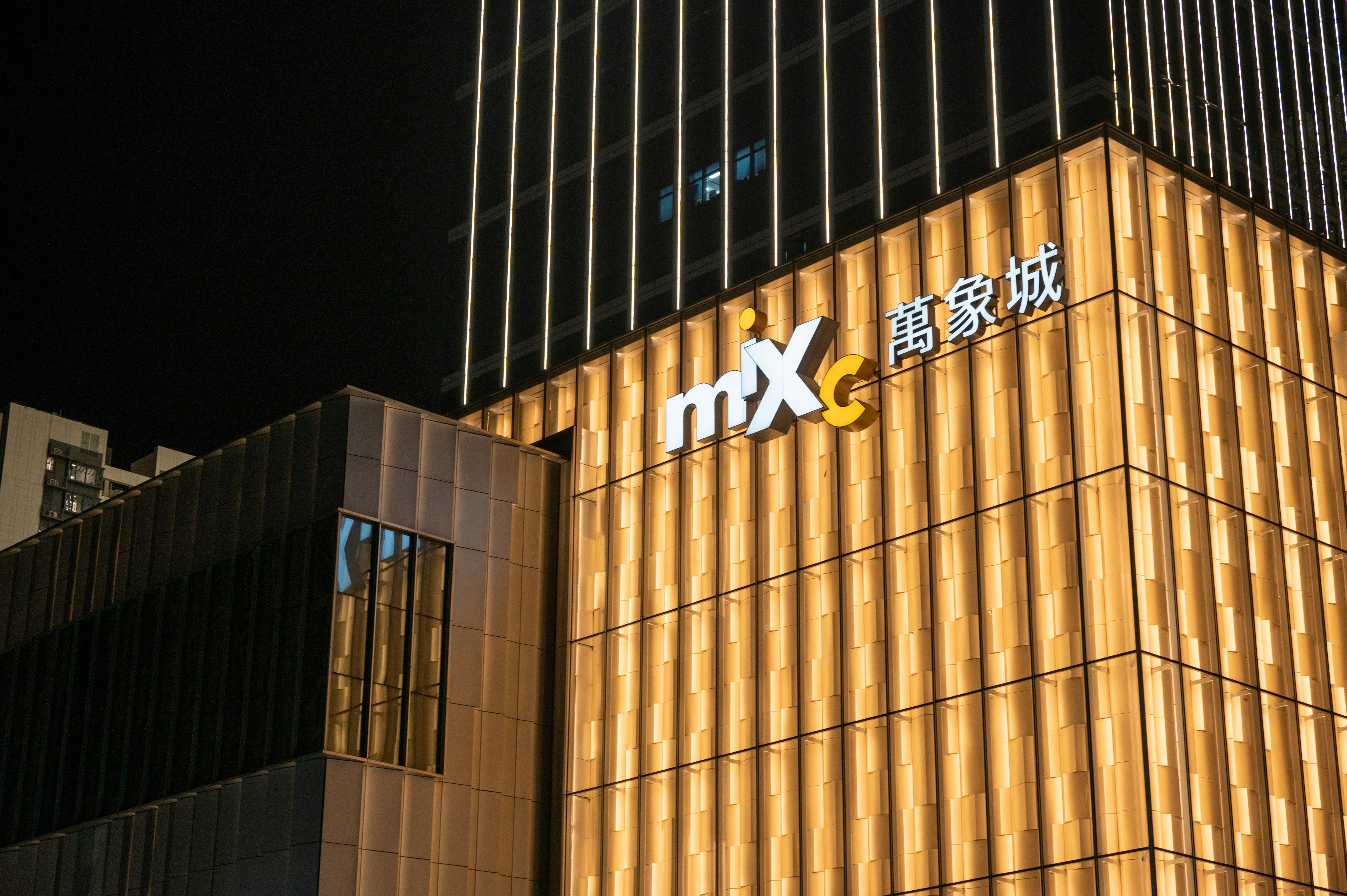 A tall building with a sign on the side of it photo – Free City Image ...