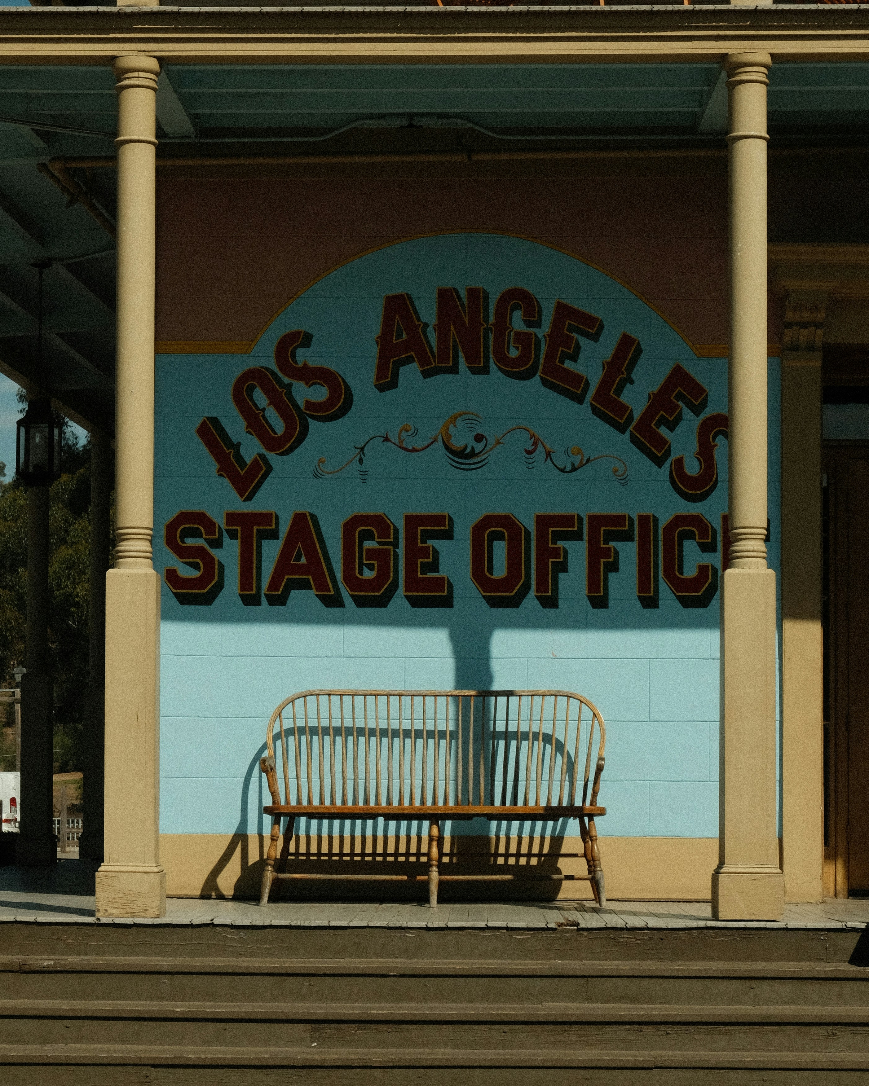 Sunlit Bench Framed by the Los Angeles Stage Office Sign