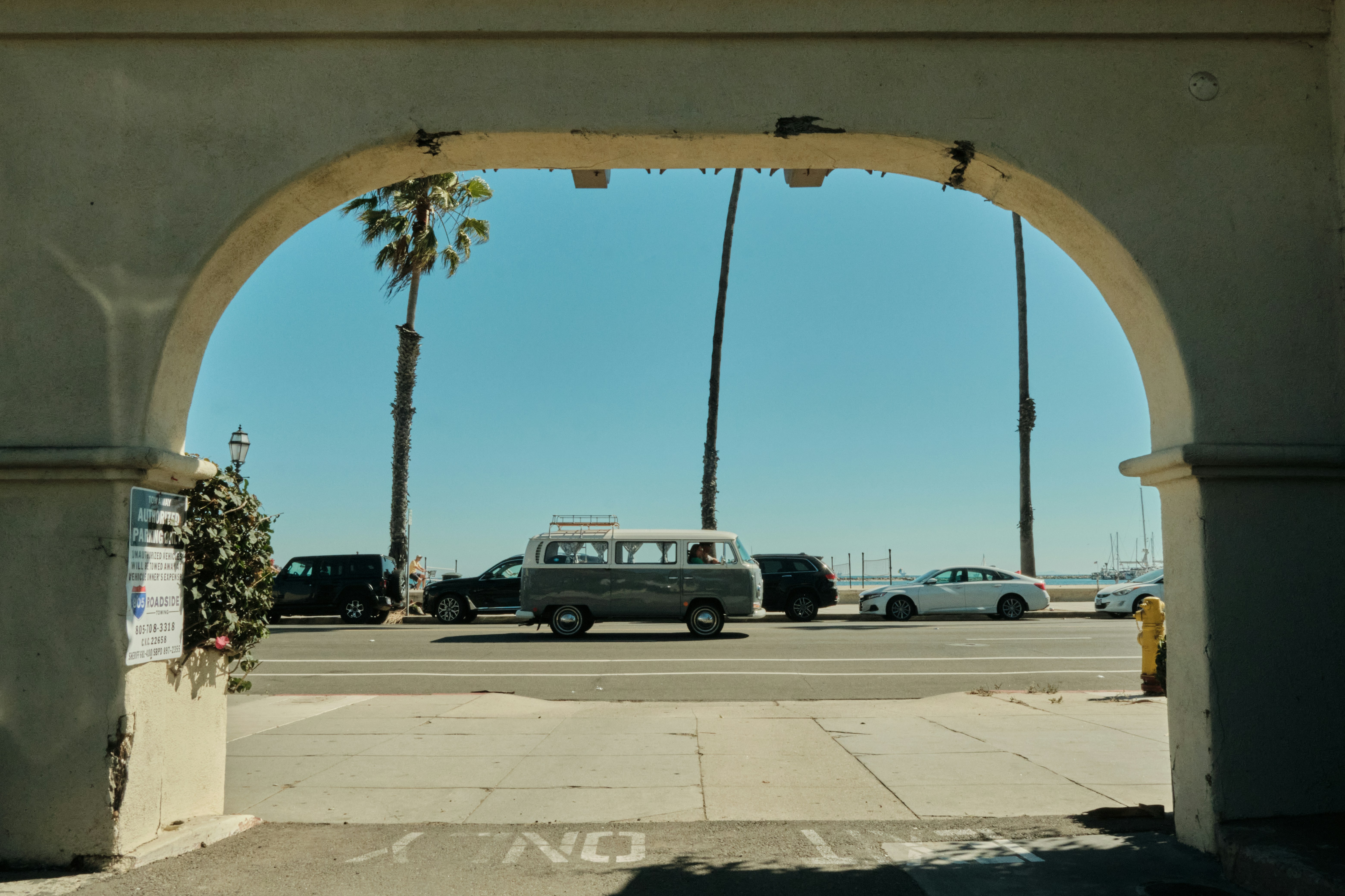A parking lot with cars parked under an archway photo – Free Santa ...