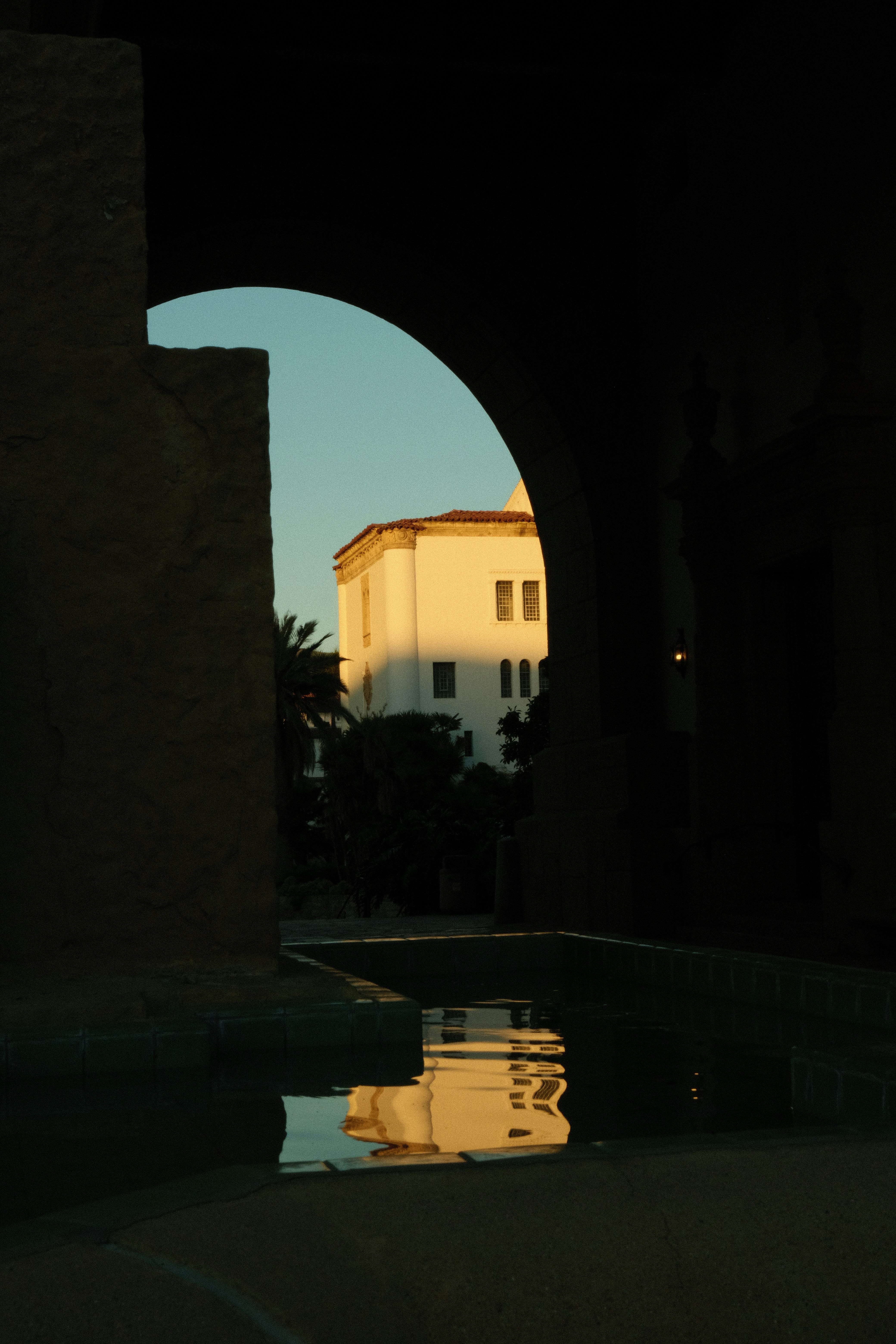 Archway Portrait: Sunlit Villa Framed by Shadow