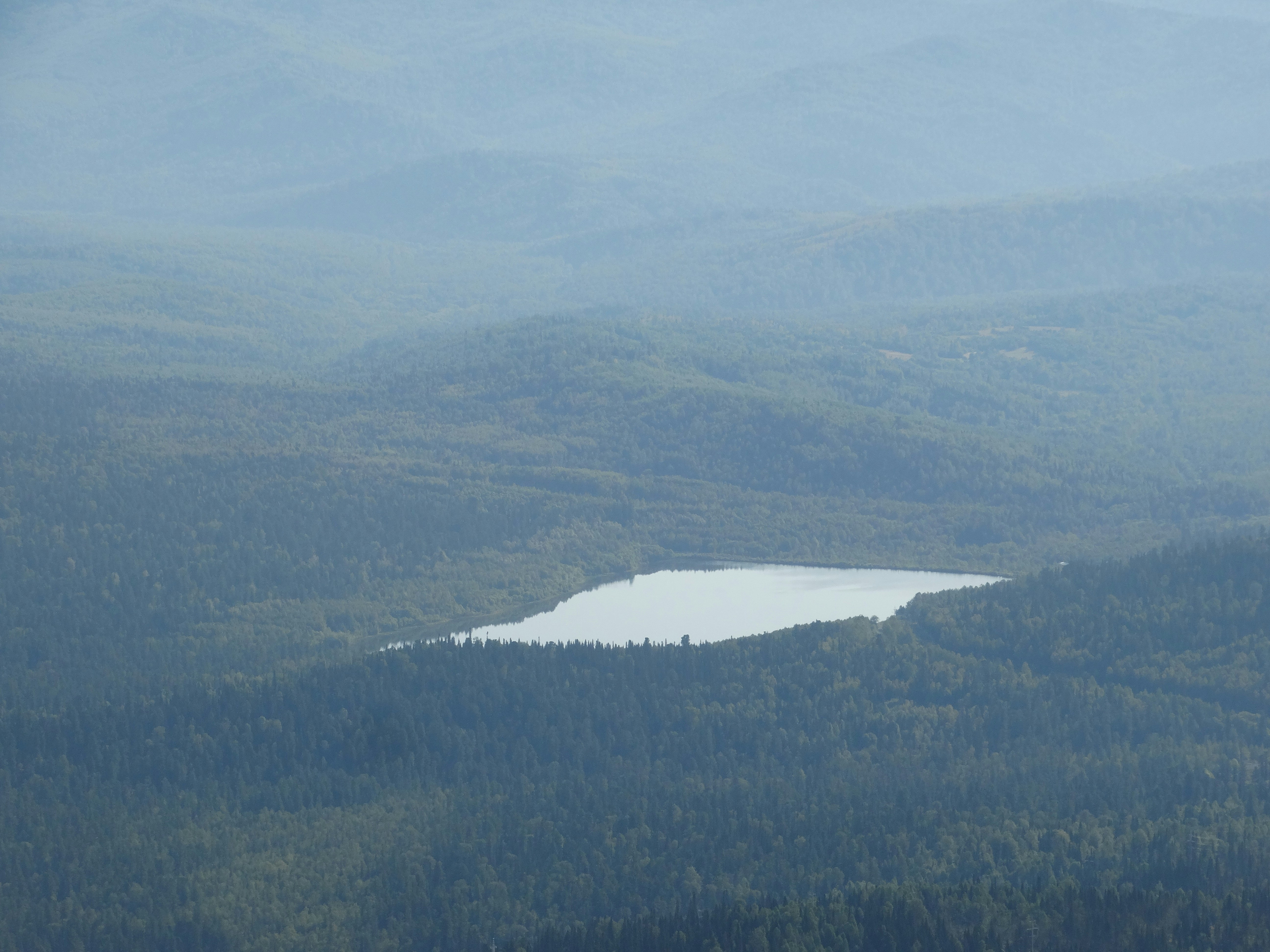 Aerial Tranquility: Lake Amidst the Mountain Veil