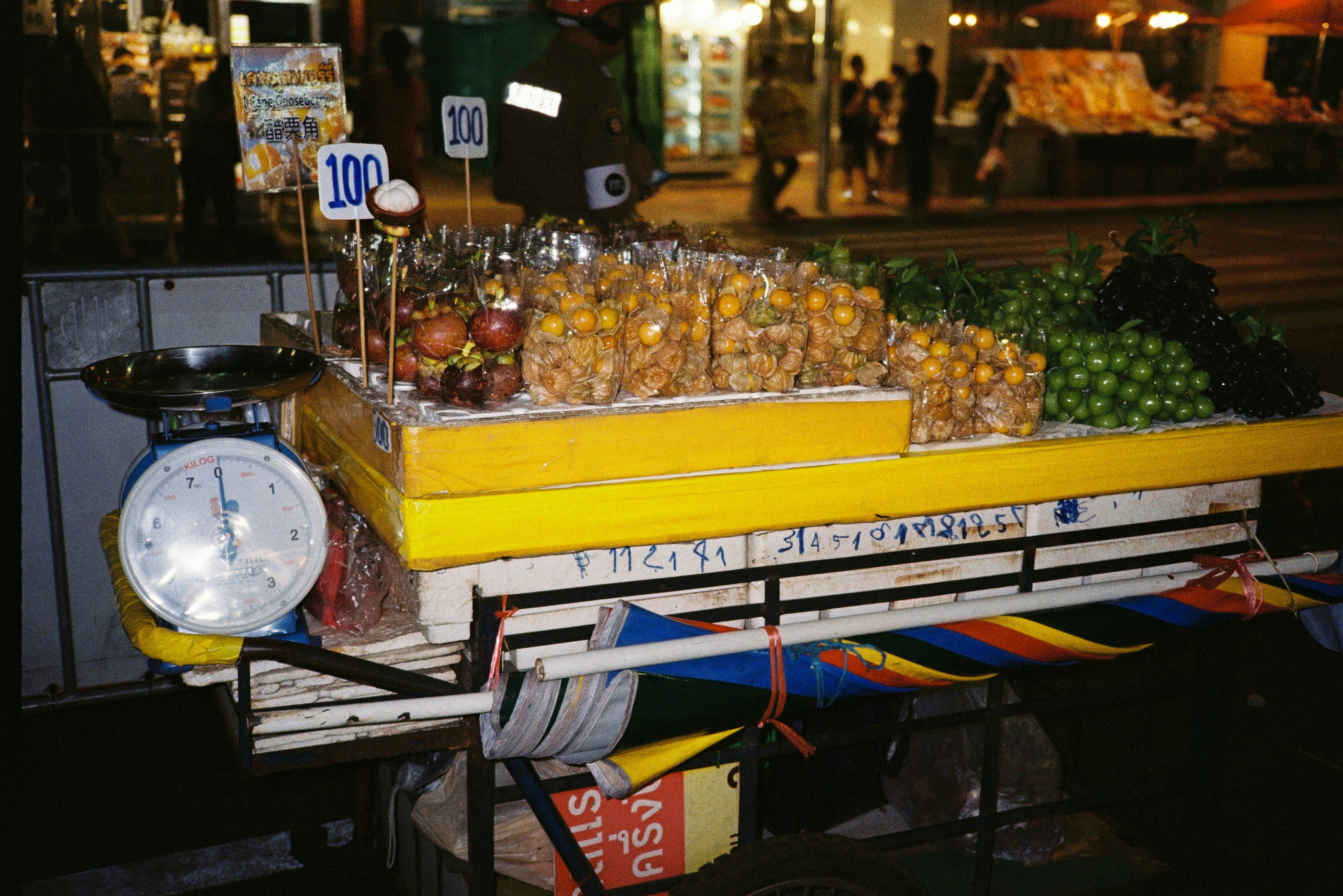 A fruit stand in the middle of a street at night photo – Free Food ...