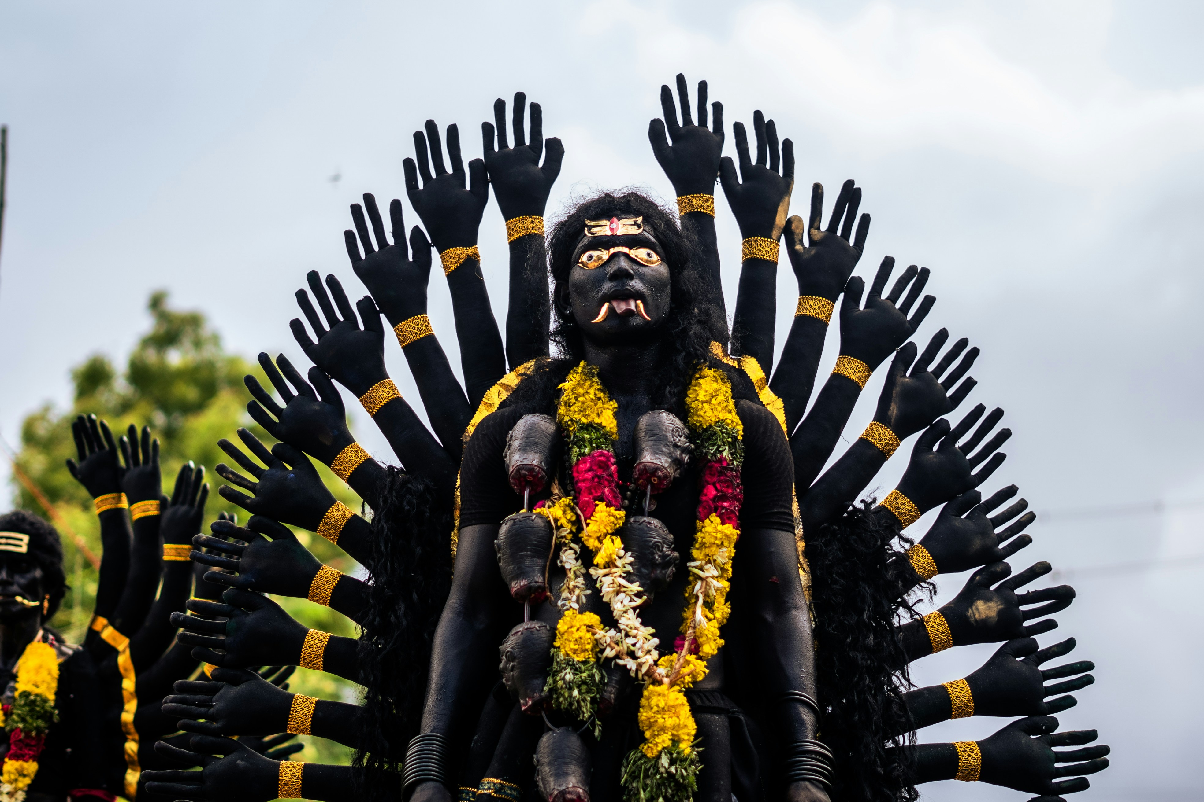 Hierarchy in Gold and Petals: The Central Idol with Radiating Hands