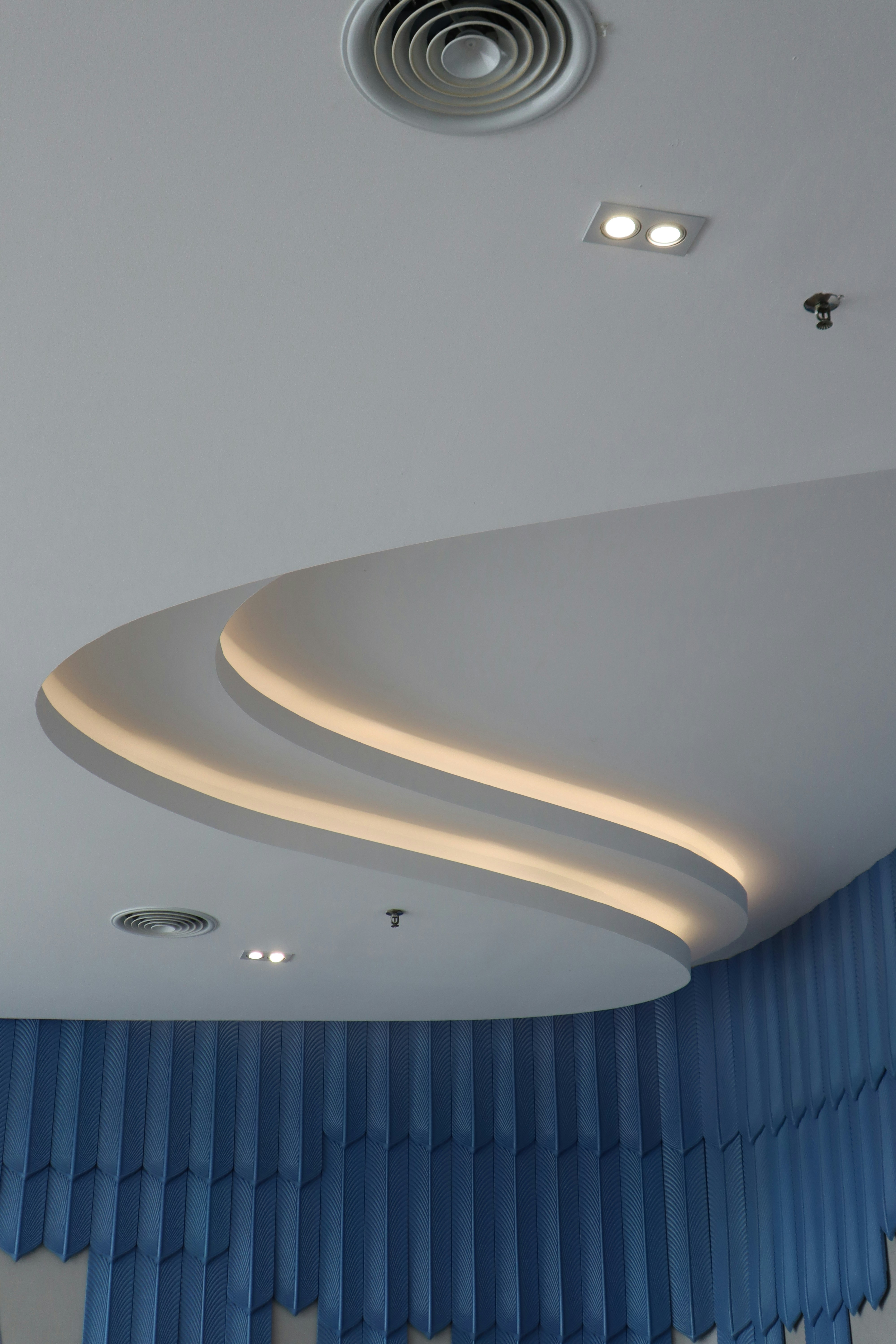 Curved ceiling glow over blue acoustic waves