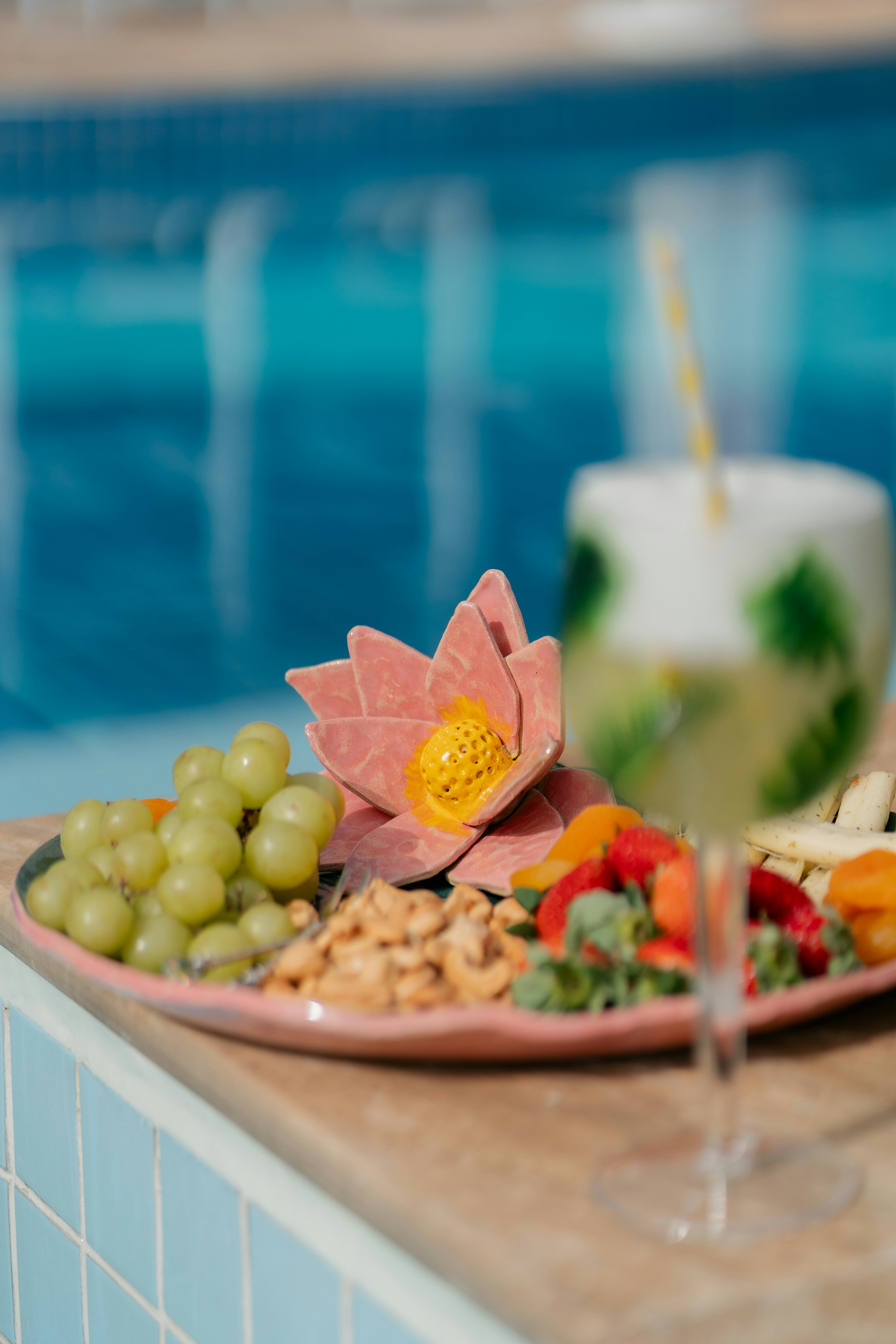 Tropical assortment by the poolside with a pink lotus centerpiece