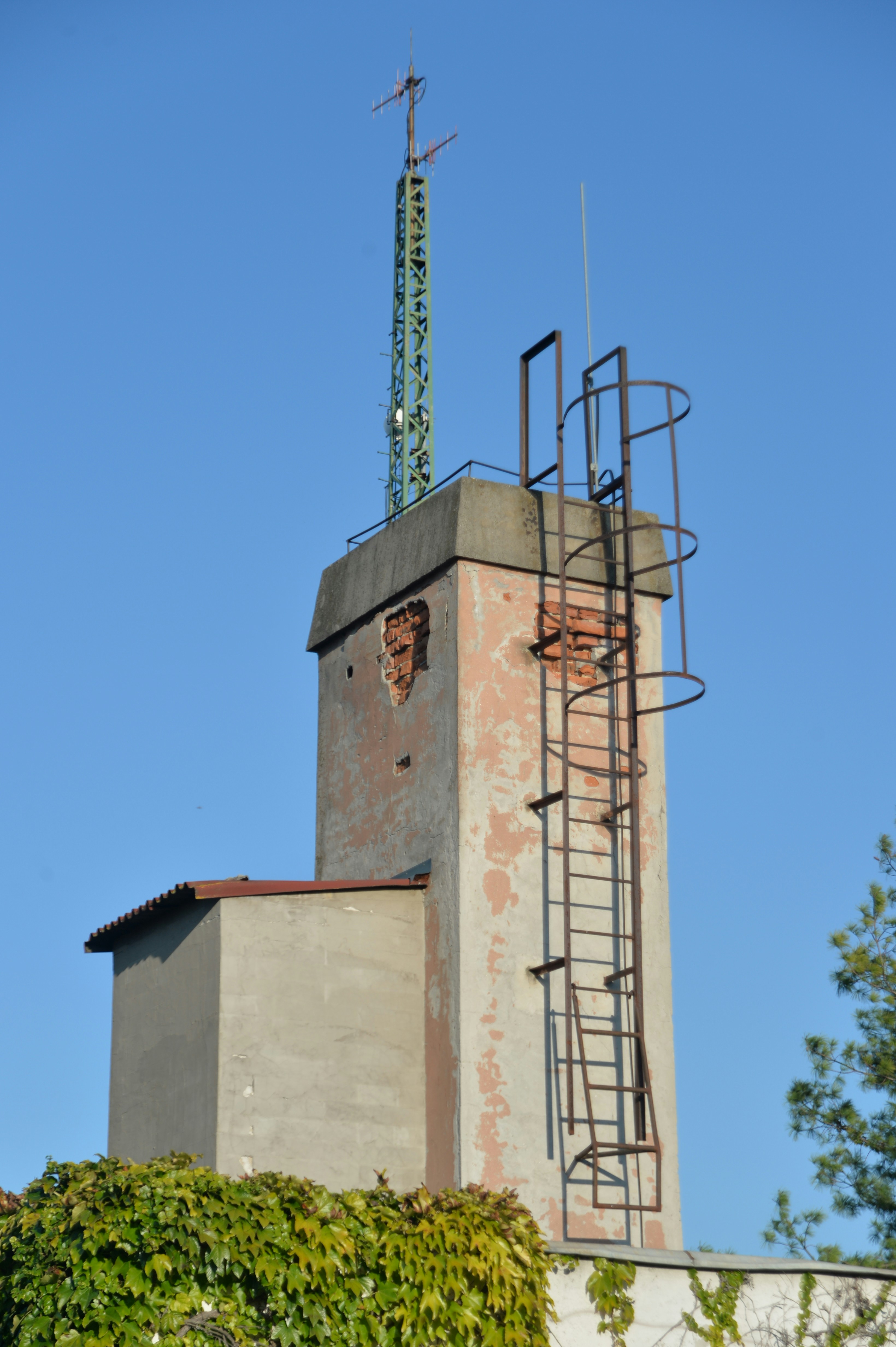 Rusted Chimney Tower Reaching Toward a Cerulean Sky