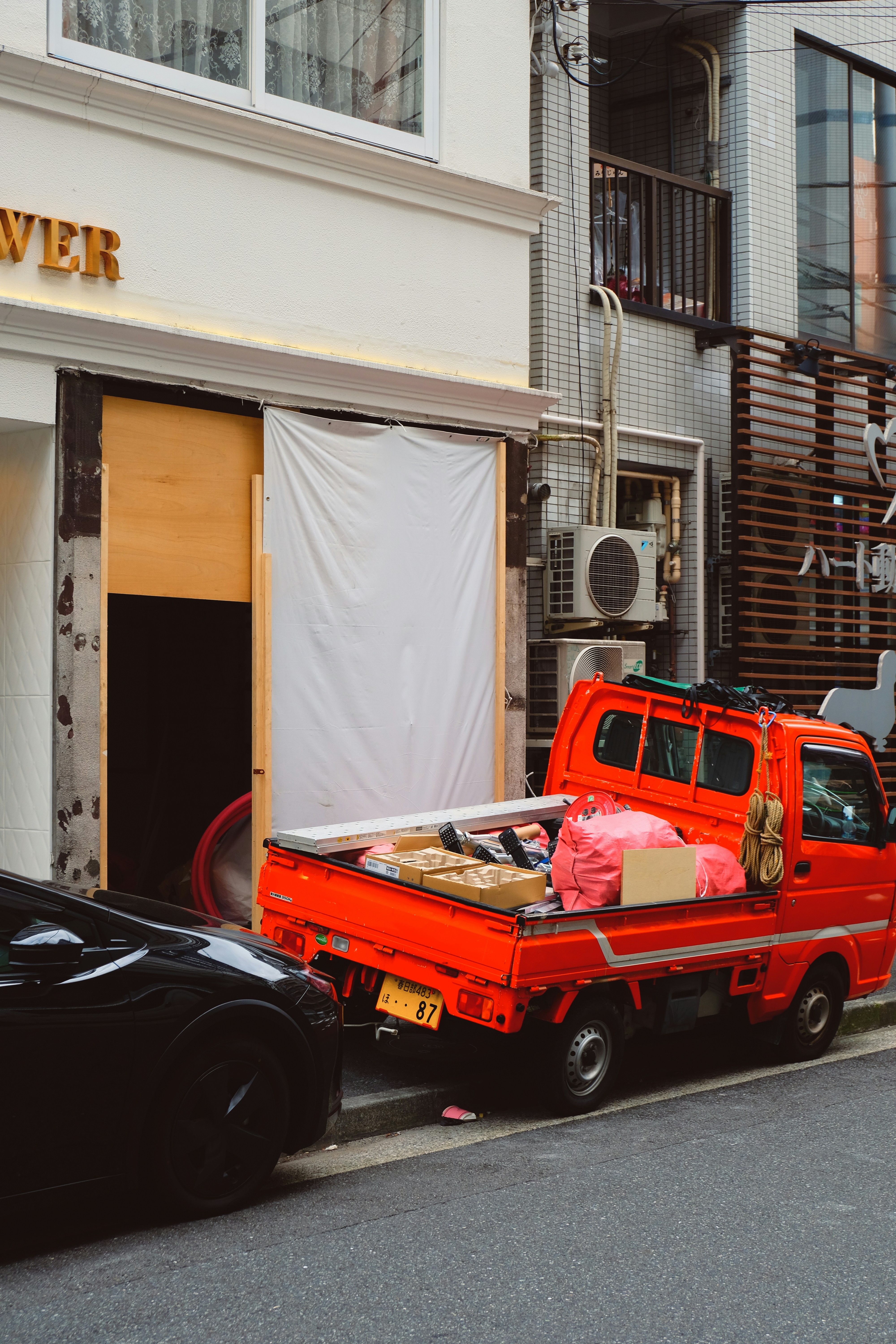 Crimson Cargo at a Curtain-Front Corner