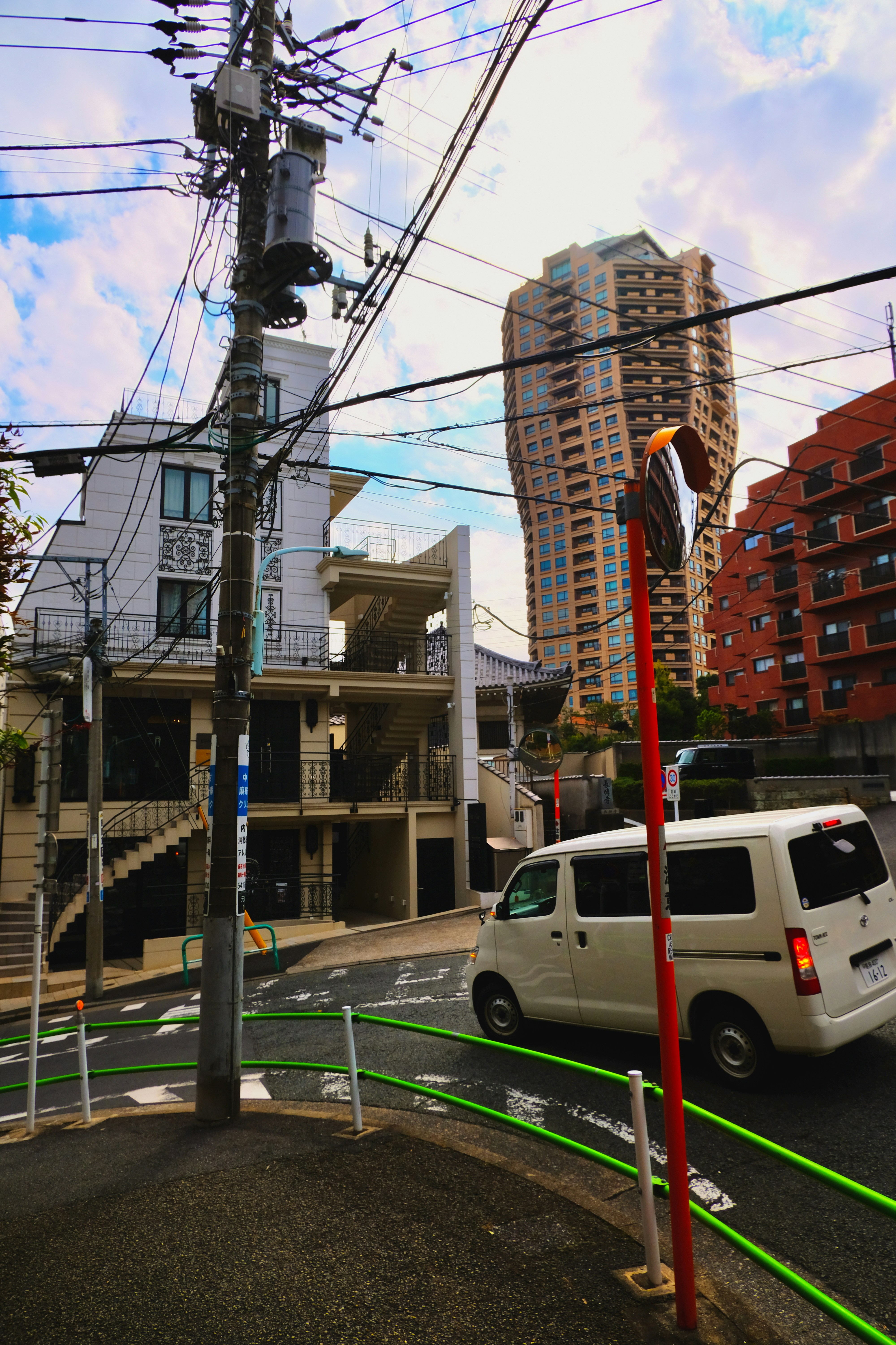 Wired Crossroads: A Sunlit City Street Under a Web of Cables