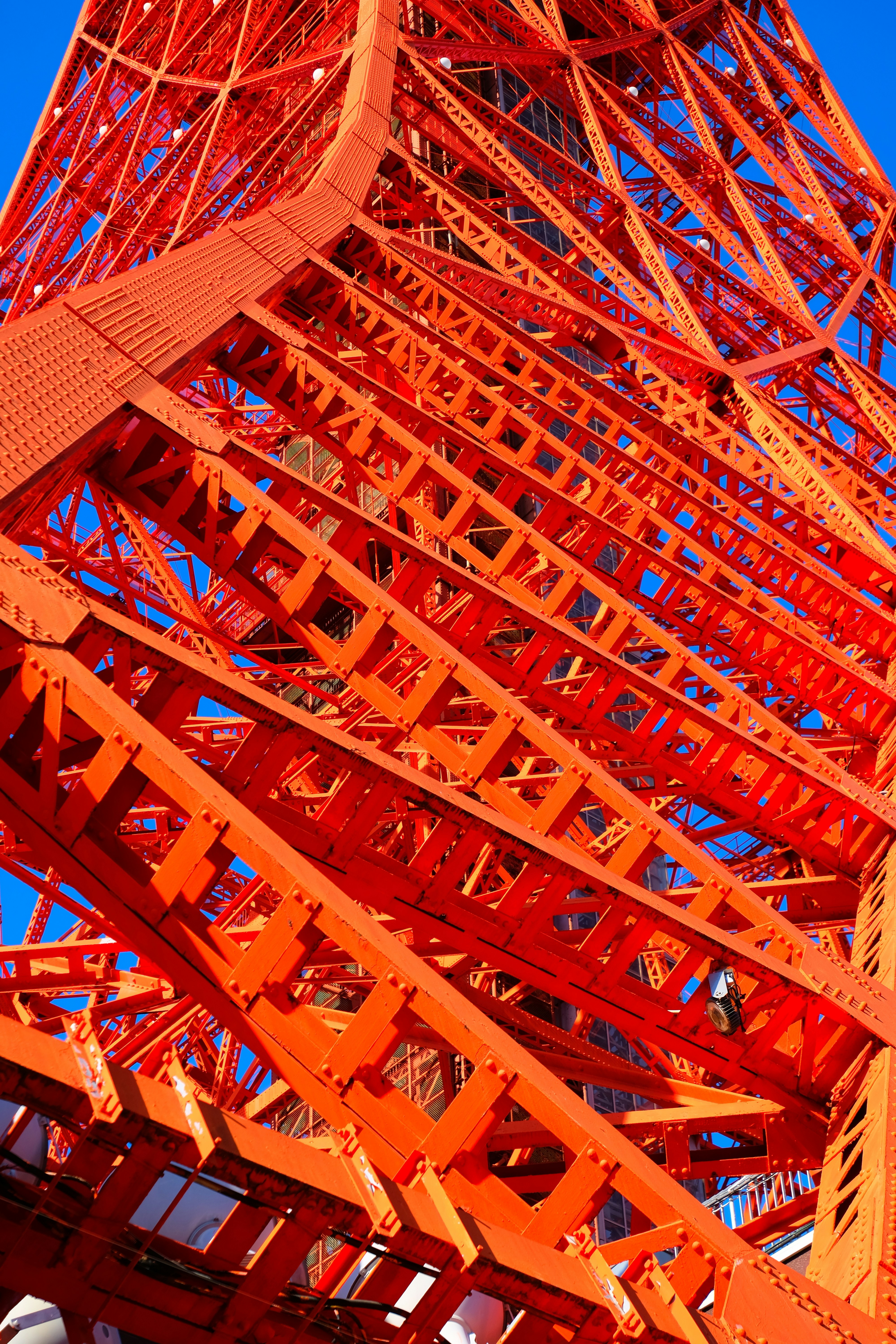 Crimson Lattice Under a Blue Sky: A Close-Up of Red Steel Truss