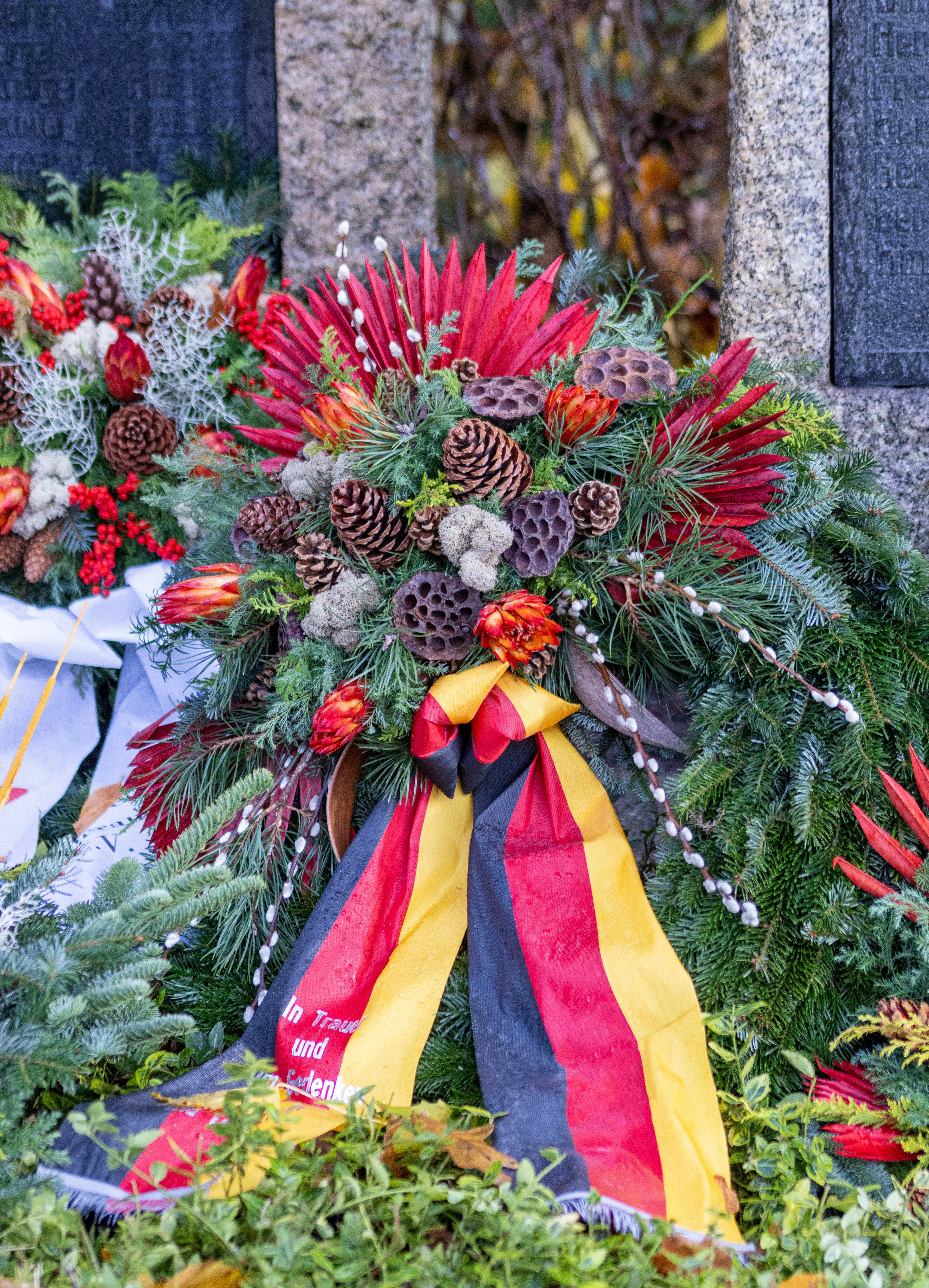 A wreath with pine cones and red and yellow ribbons photo – Free ...