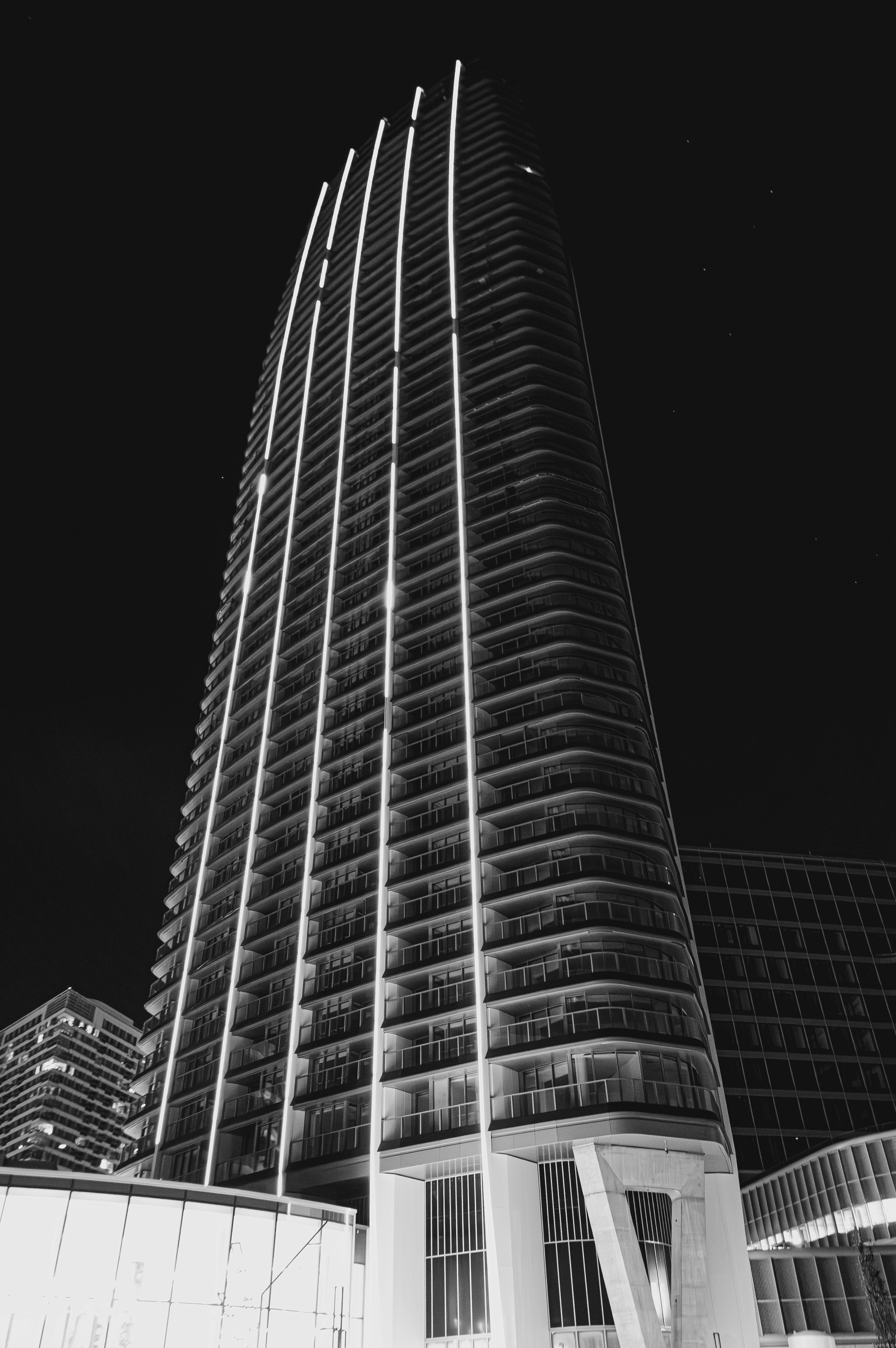 Nightfall Monolith: Vertical Light Stripes Crown a Skyscraper
