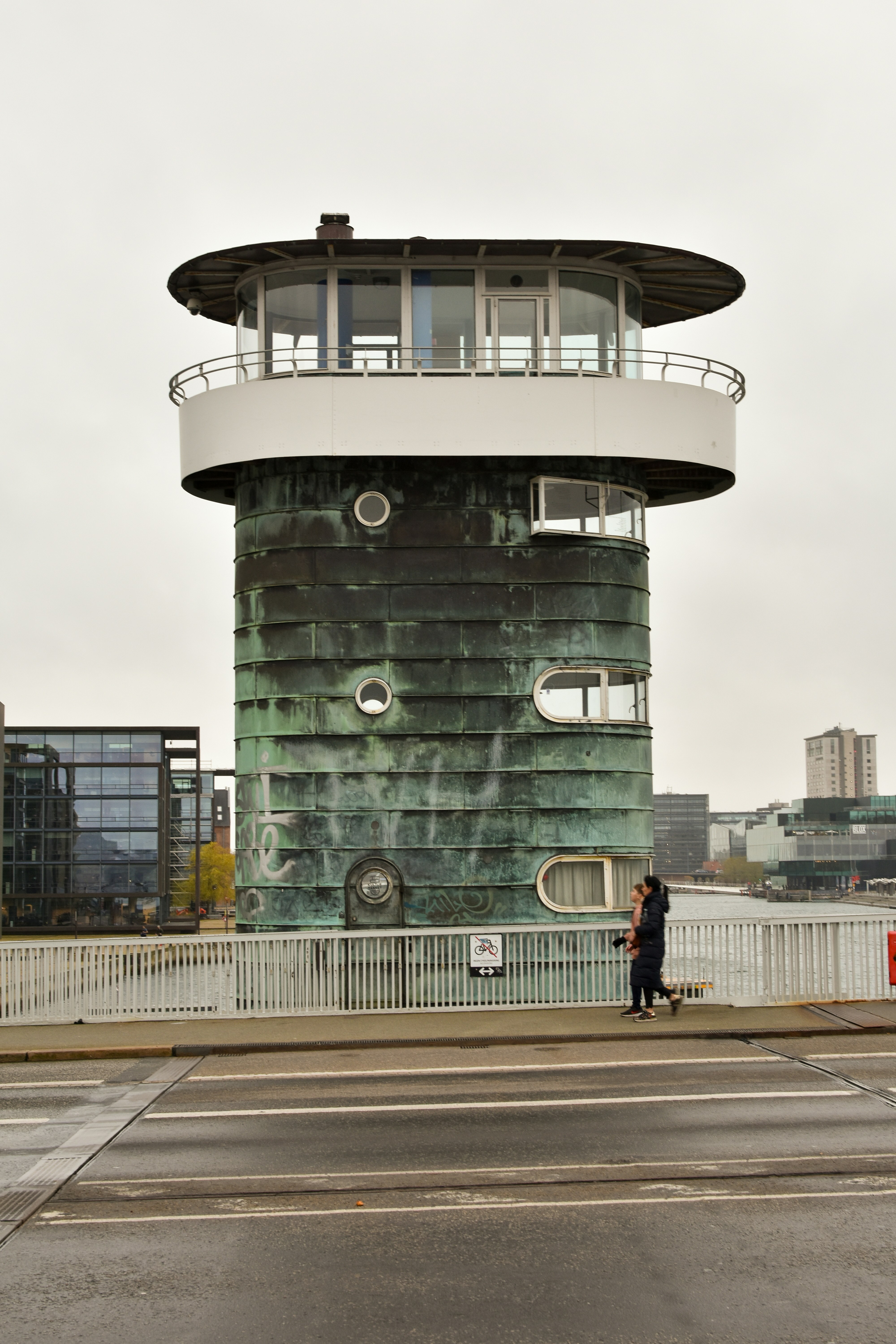 Patinaed Riverside Lookout: Cylindrical Tower Framing the City