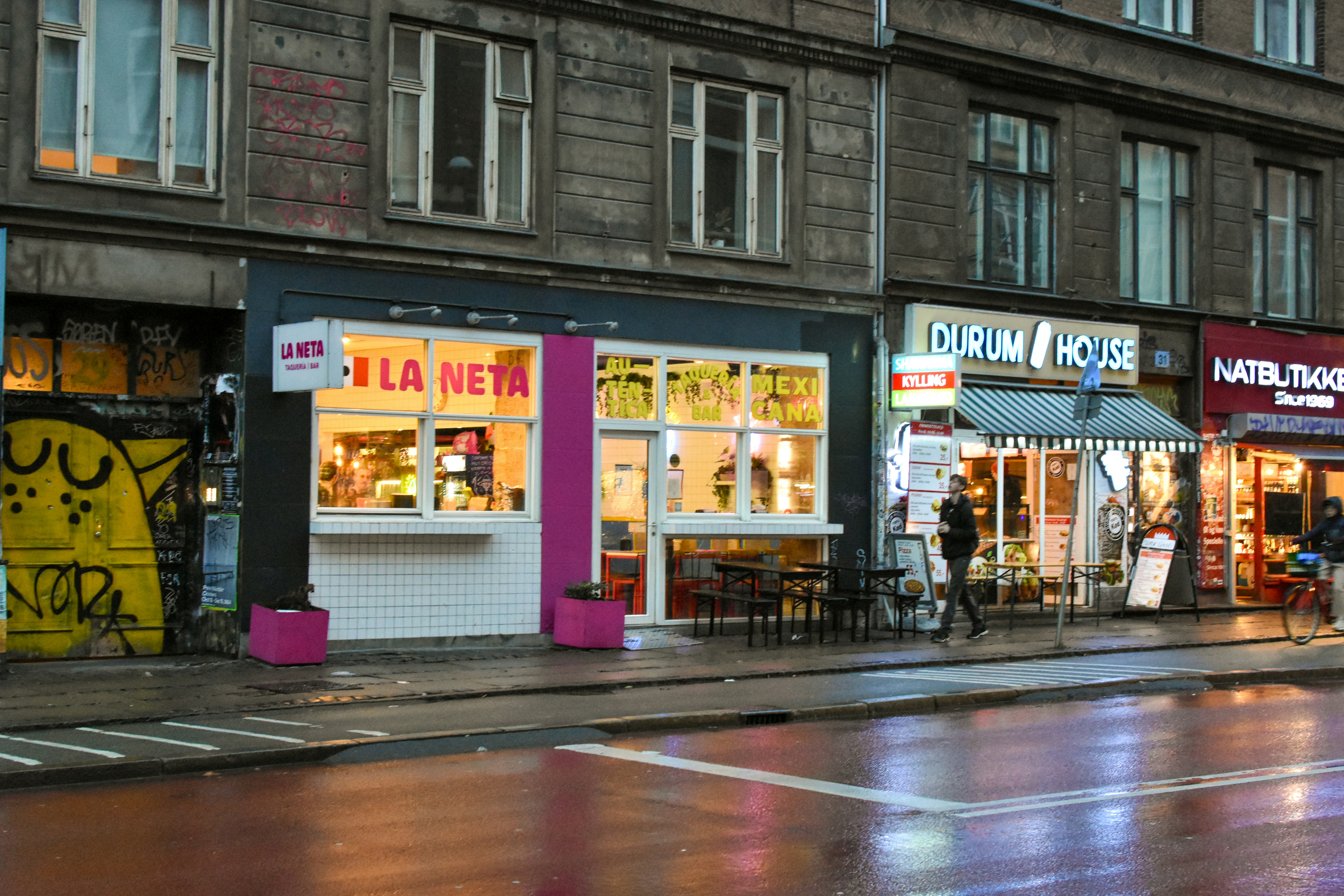 A city street with a row of shops on the side of it photo – Free ...