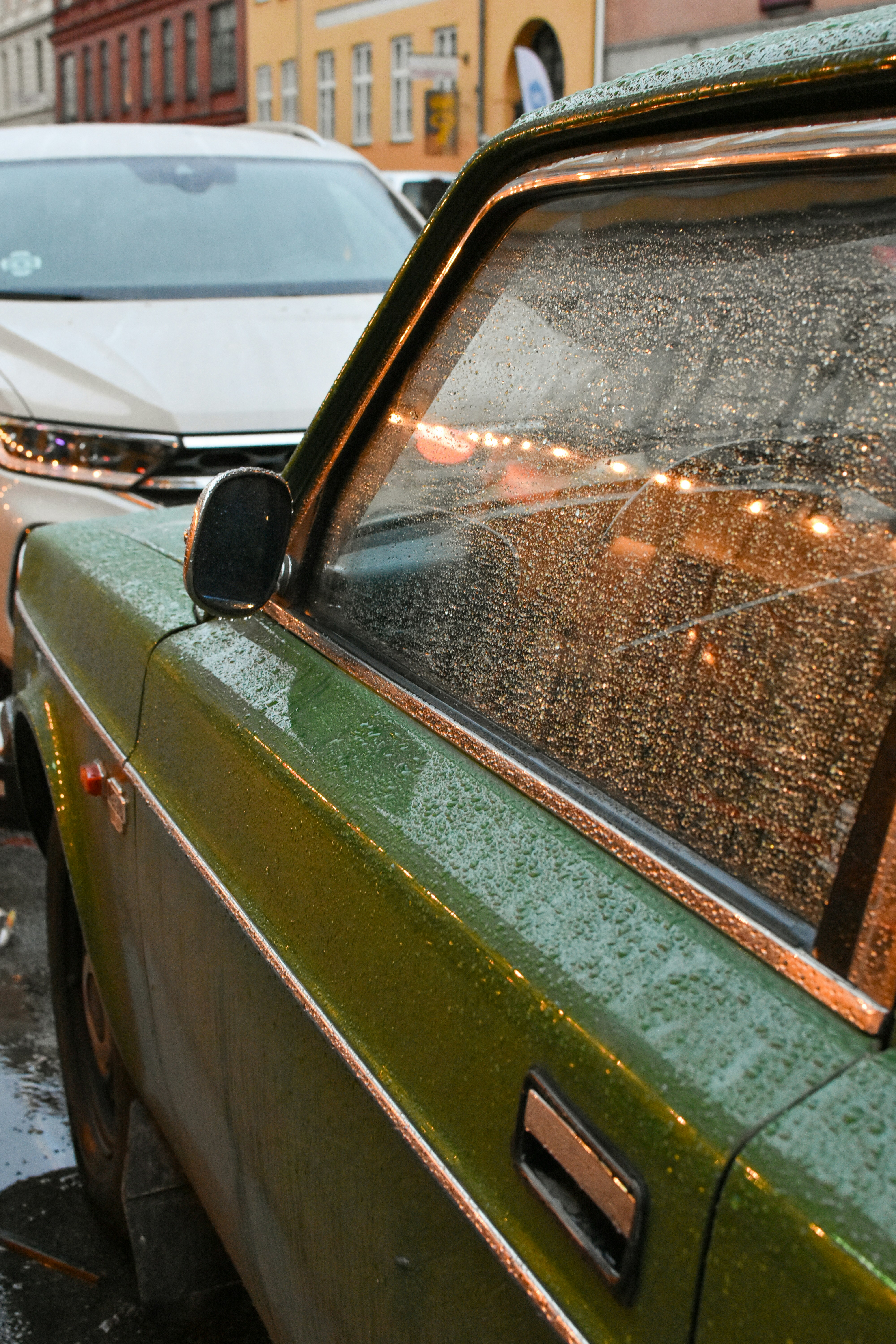 Green Vintage Car at Rainy Street: Rain Beads on Chrome
