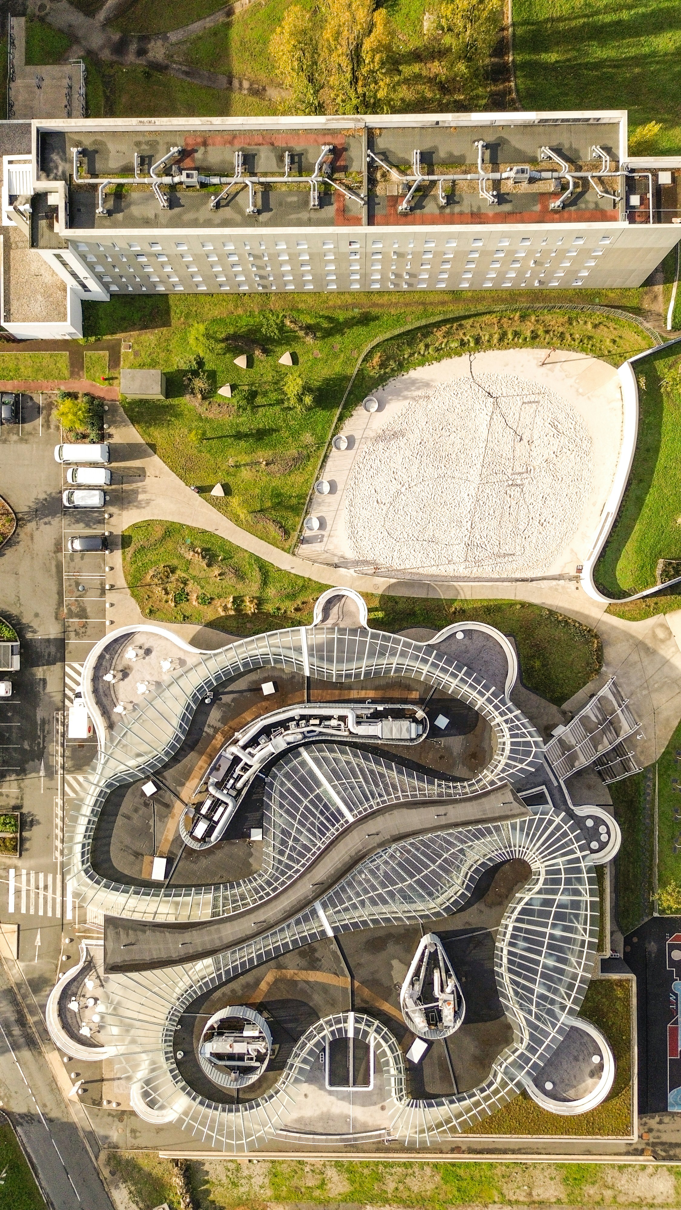 An aerial view of a building with a lot of parking spaces