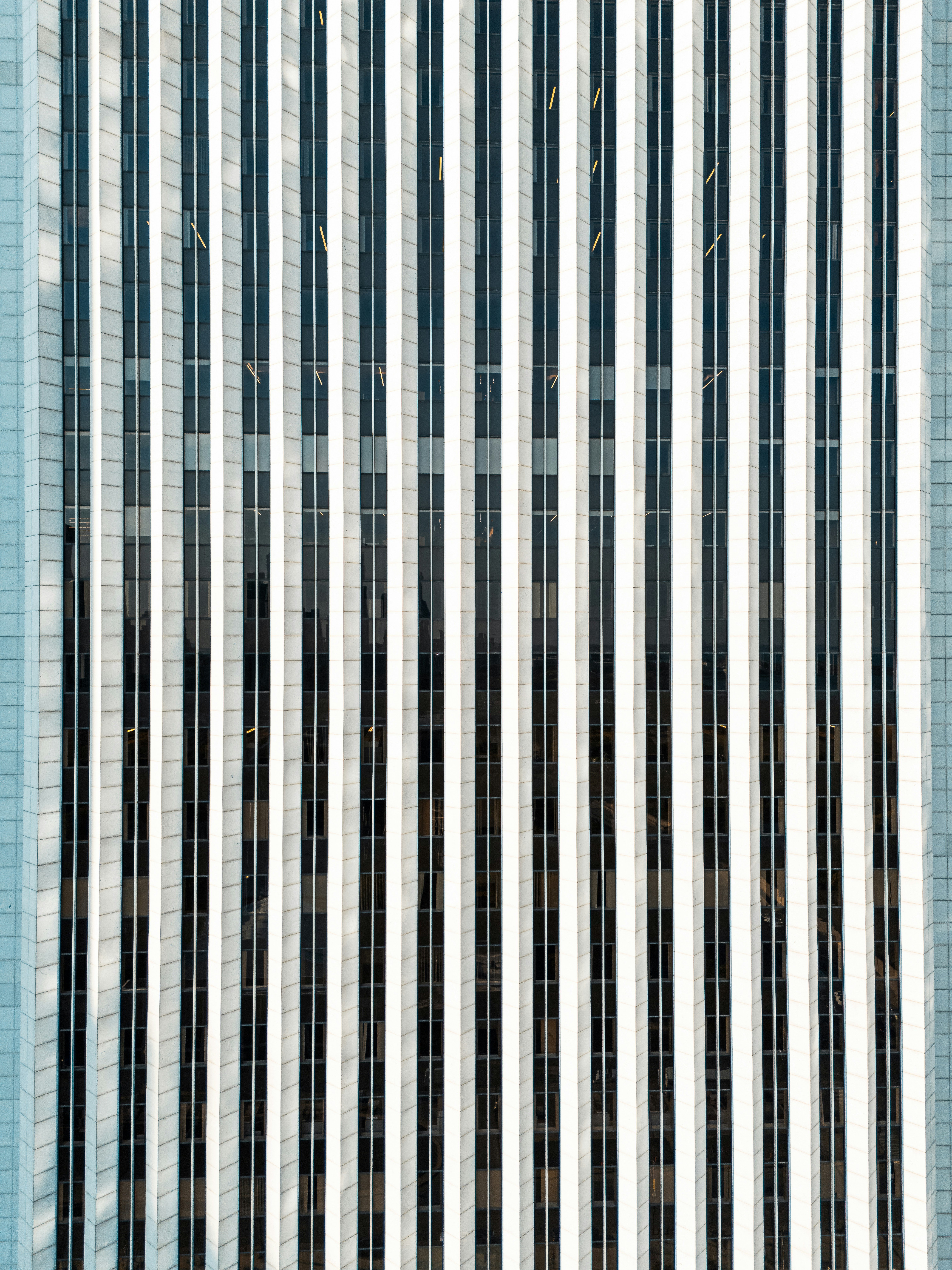 A tall building with many vertical lines on it photo – Free Pattern ...
