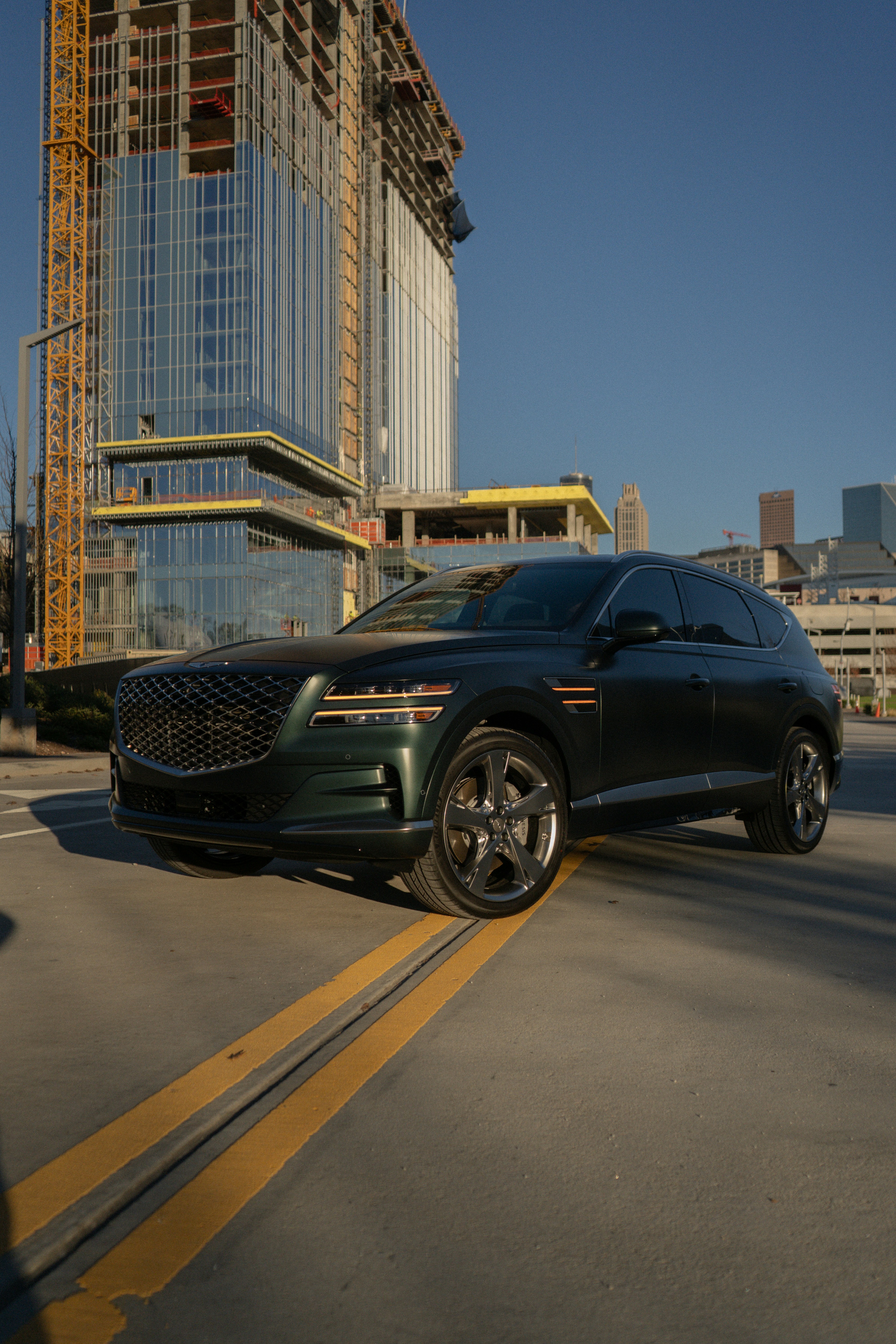 Green SUV at the Edge of a Modern Construction Zone