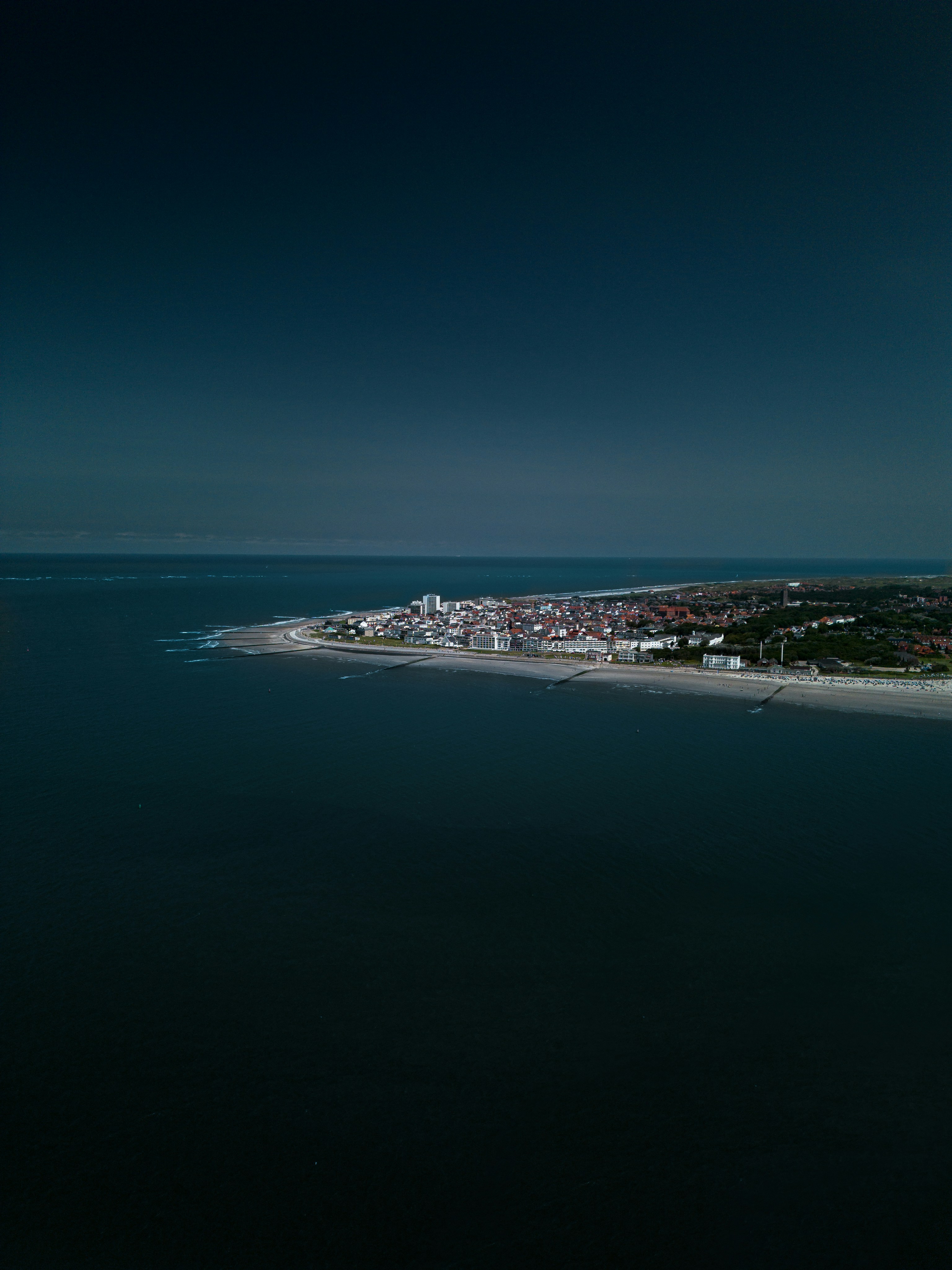 Harbor Ribbon: A Quiet Coastal Town Along a Calm Horizon