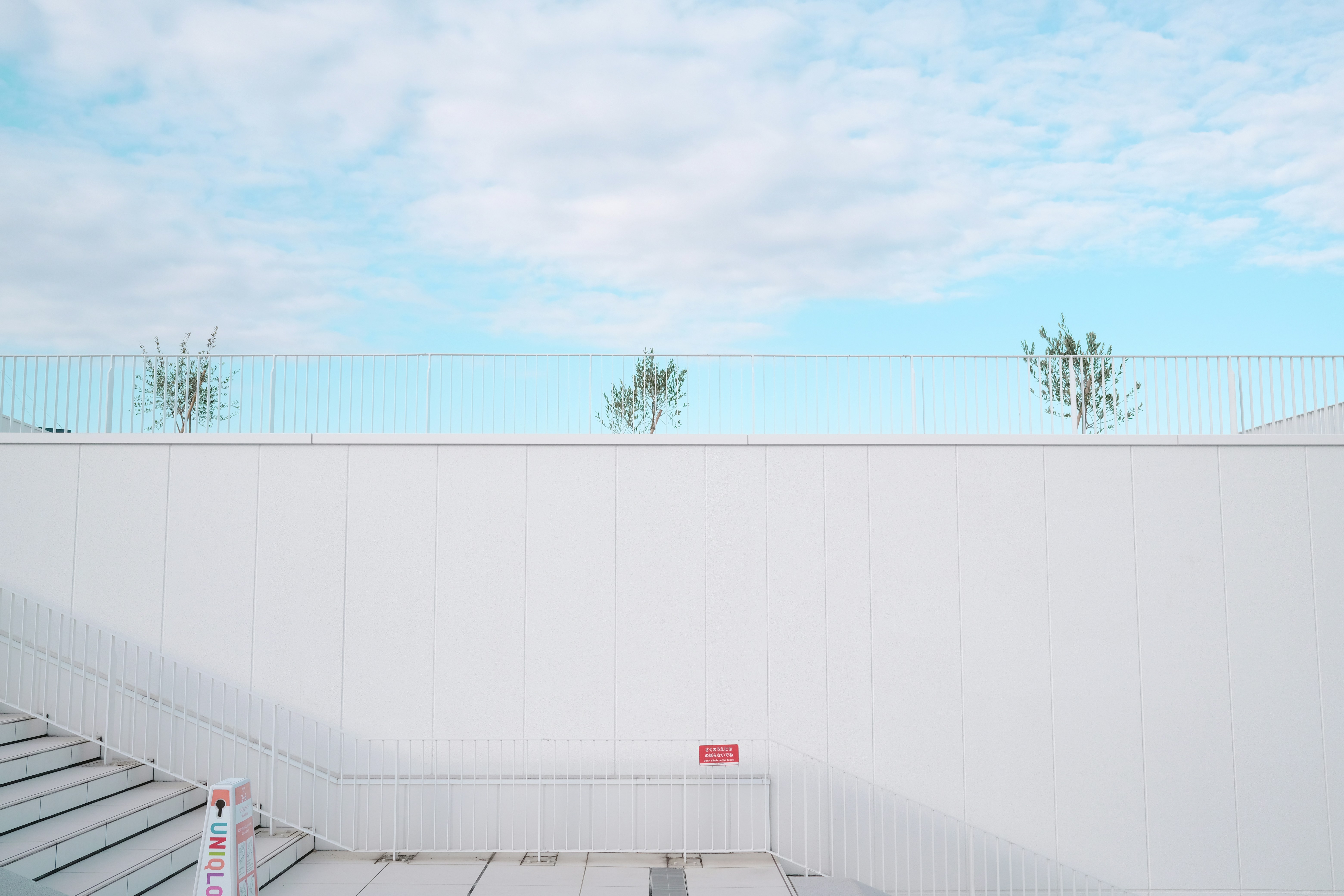Red Beacon on a Quiet White Wall: A Minimalist Architectural Moment