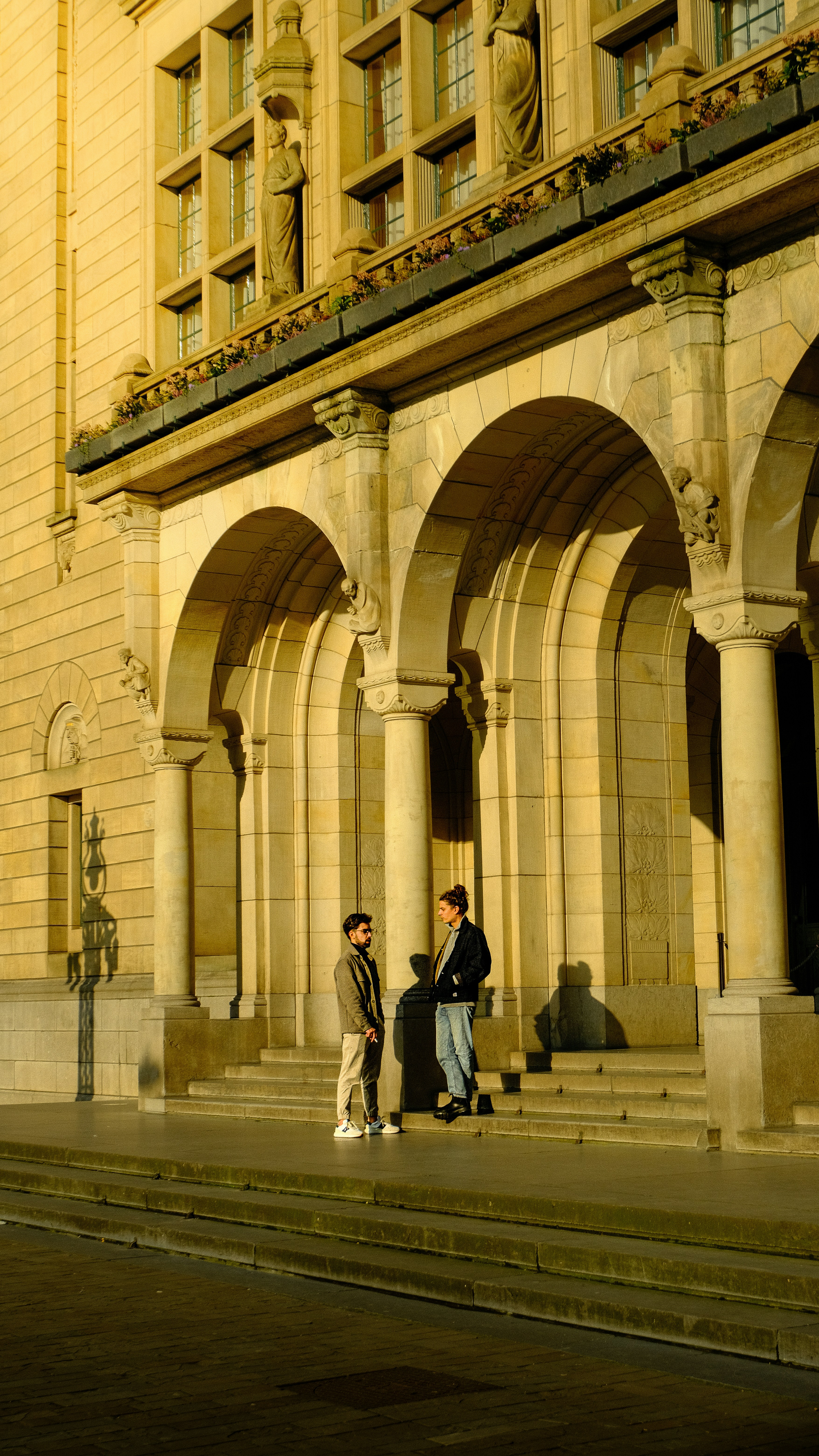 Golden Hour Dialogues Beneath the Arched Facade