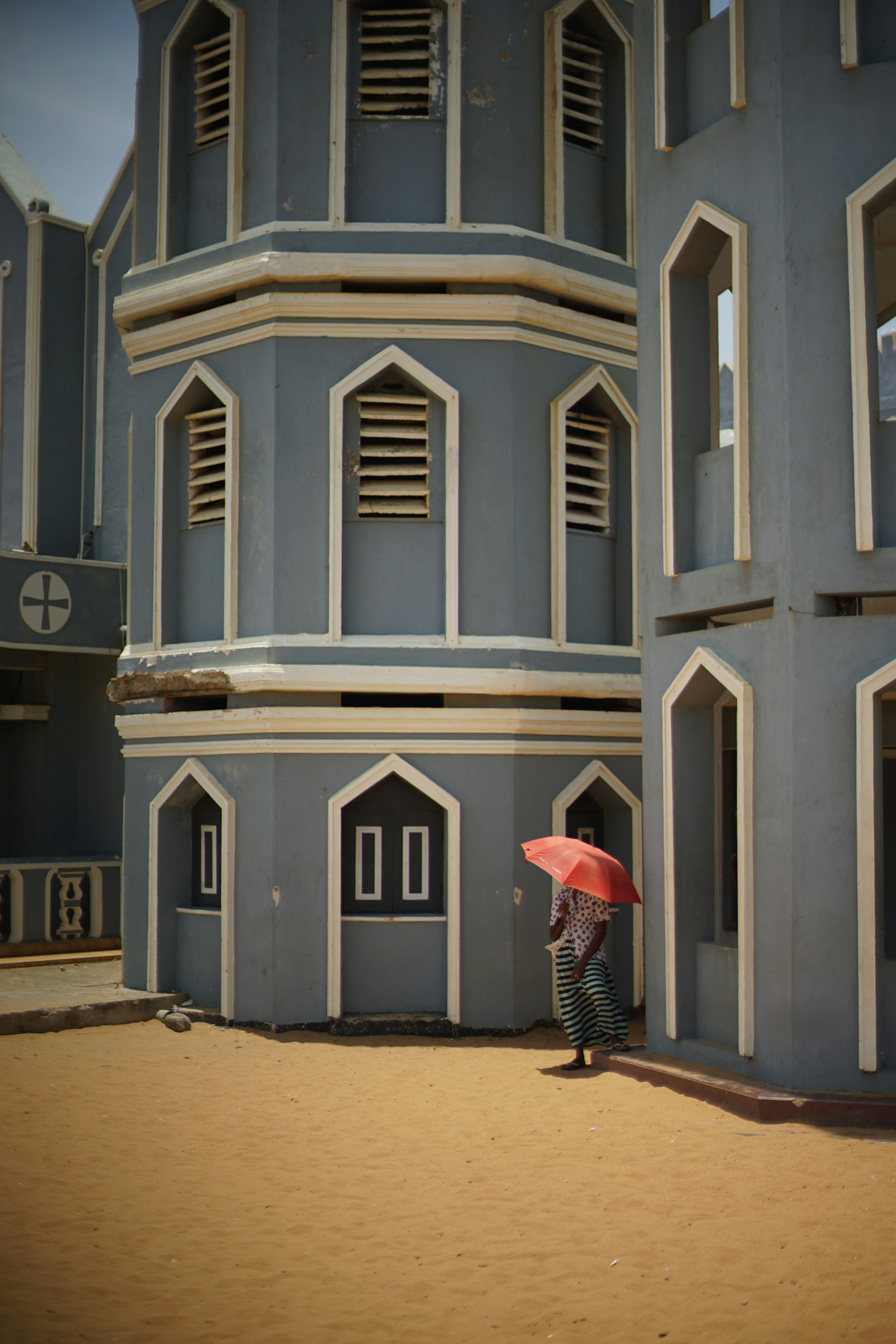 Red Umbrella at the Blue Geometric Facade