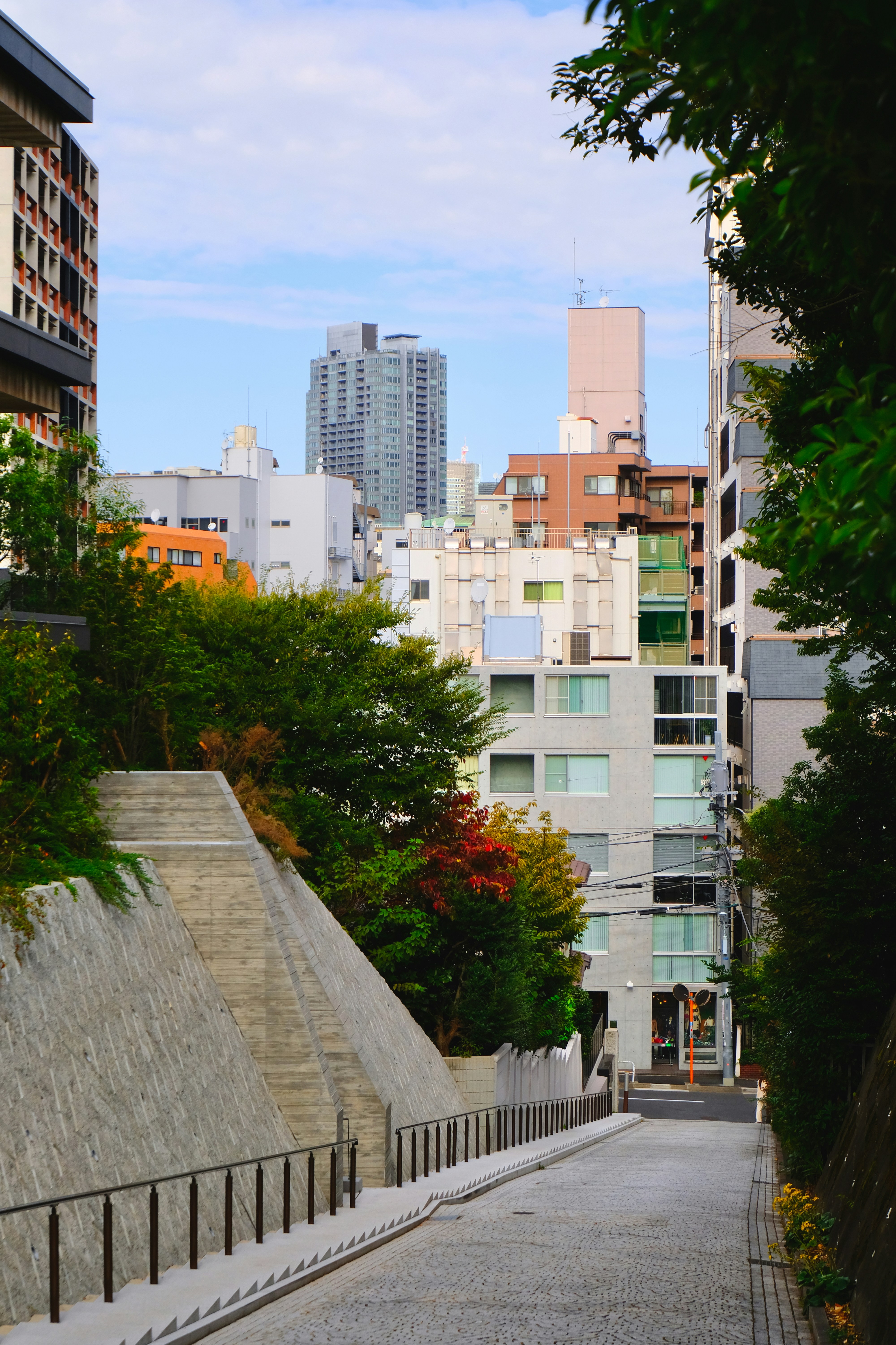 Urban Incline: A Quiet Street Between Concrete Giants
