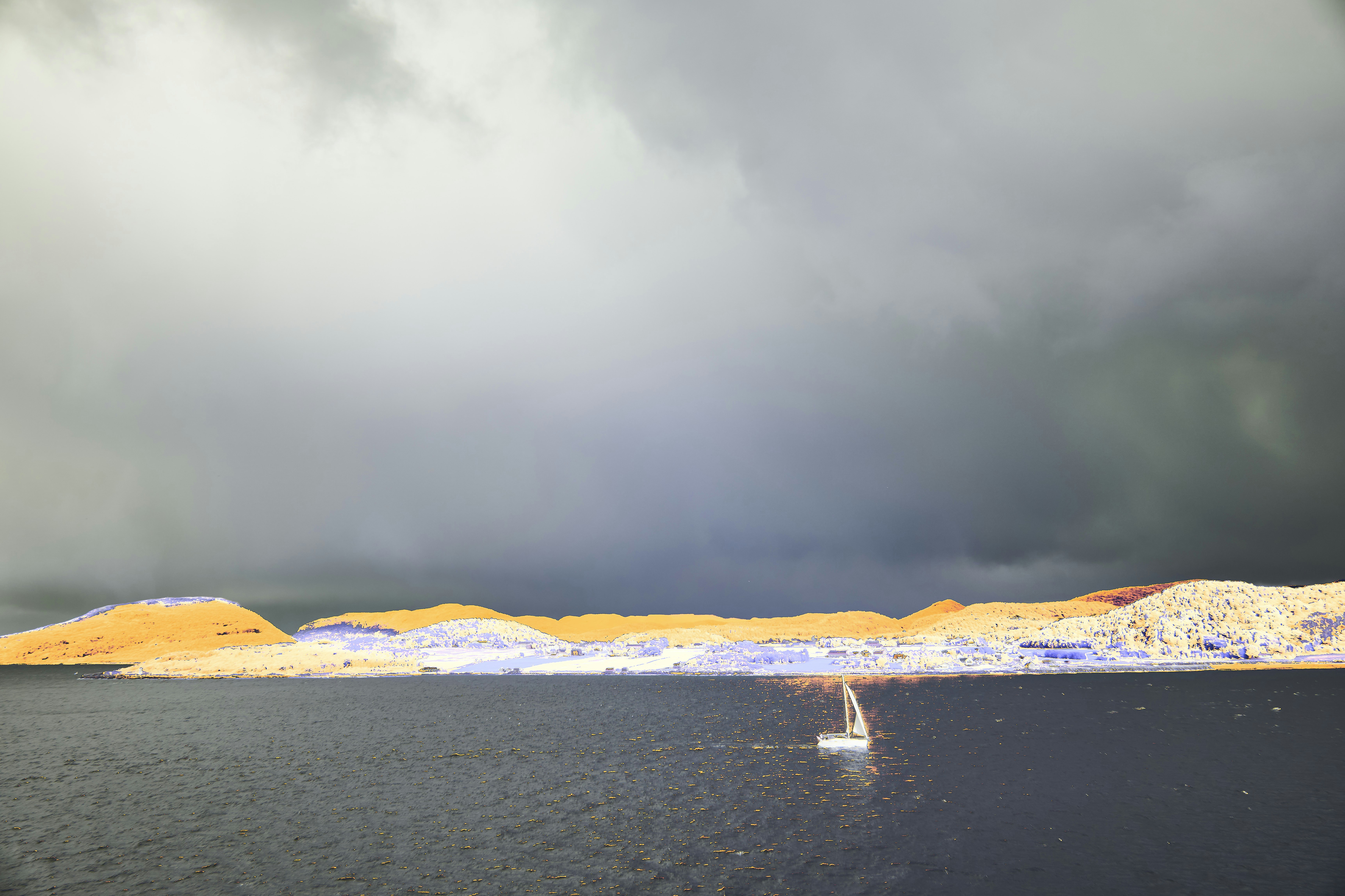Lone Sail Against a Stormlit Horizon