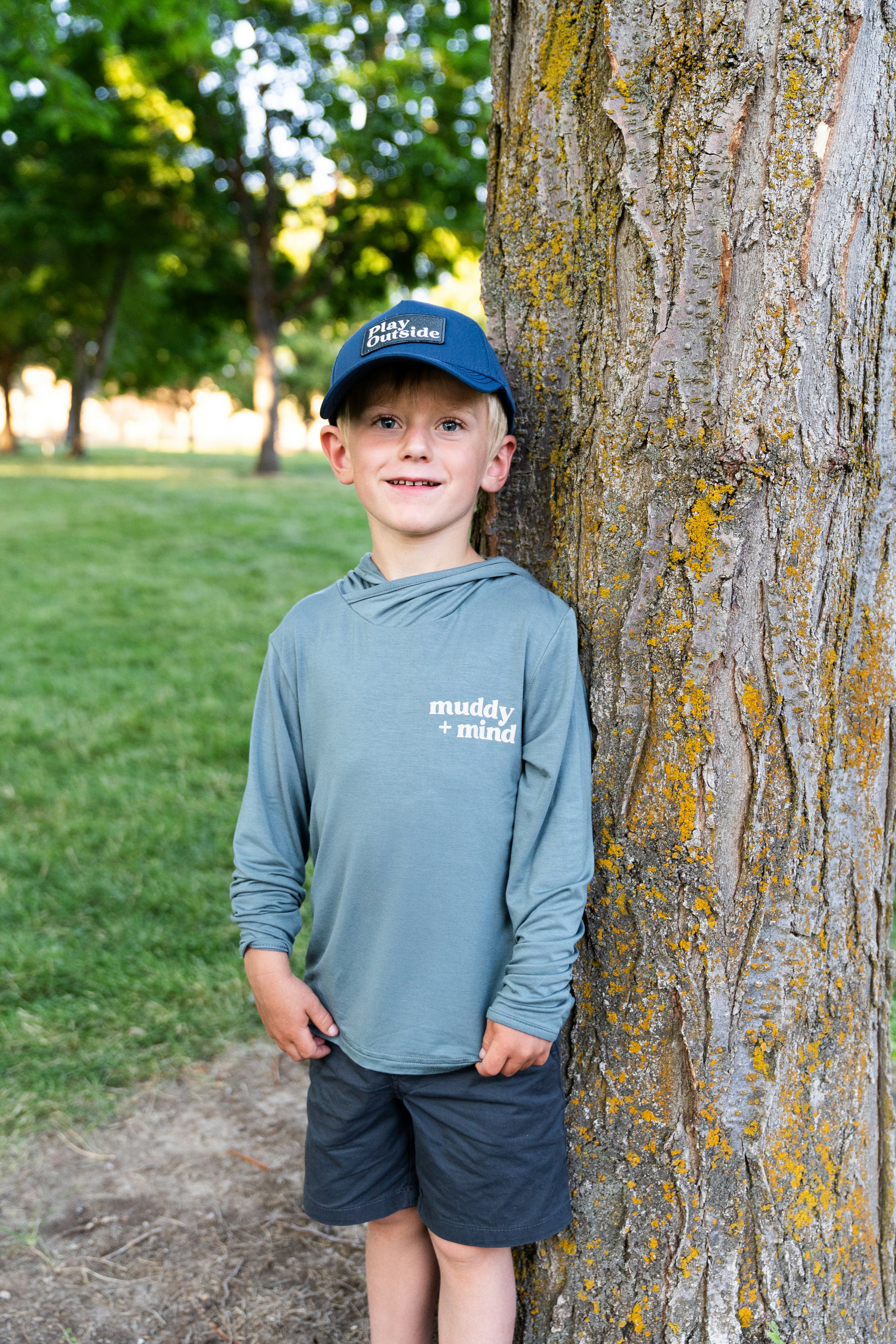 Parkside Moment: A Boy Finds Shade and Light by the Tree