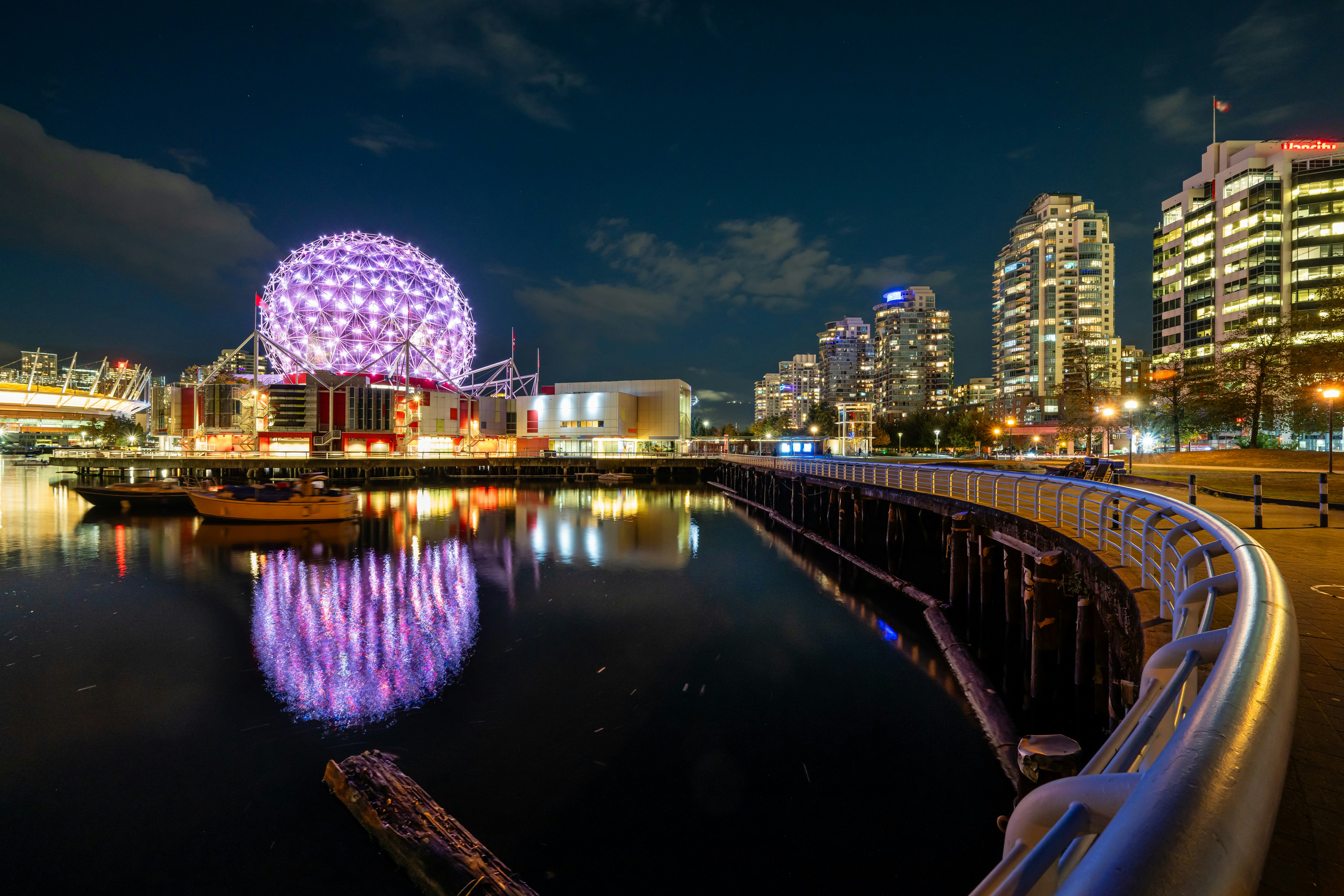 Geodesic Glow Over the Marina: Neon Sphere and Reflections
