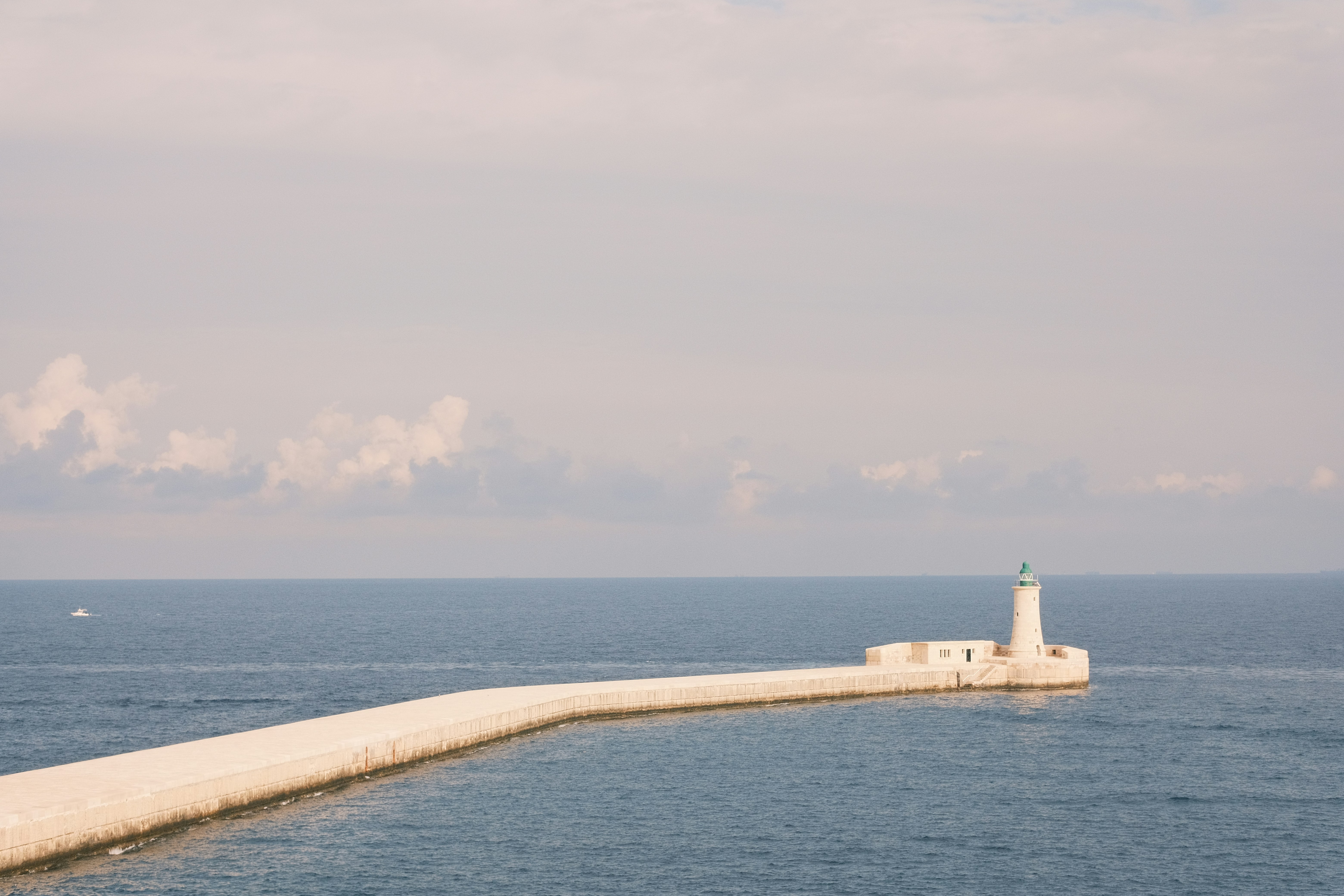 A light house on the edge of a body of water photo – Free Malta Image ...