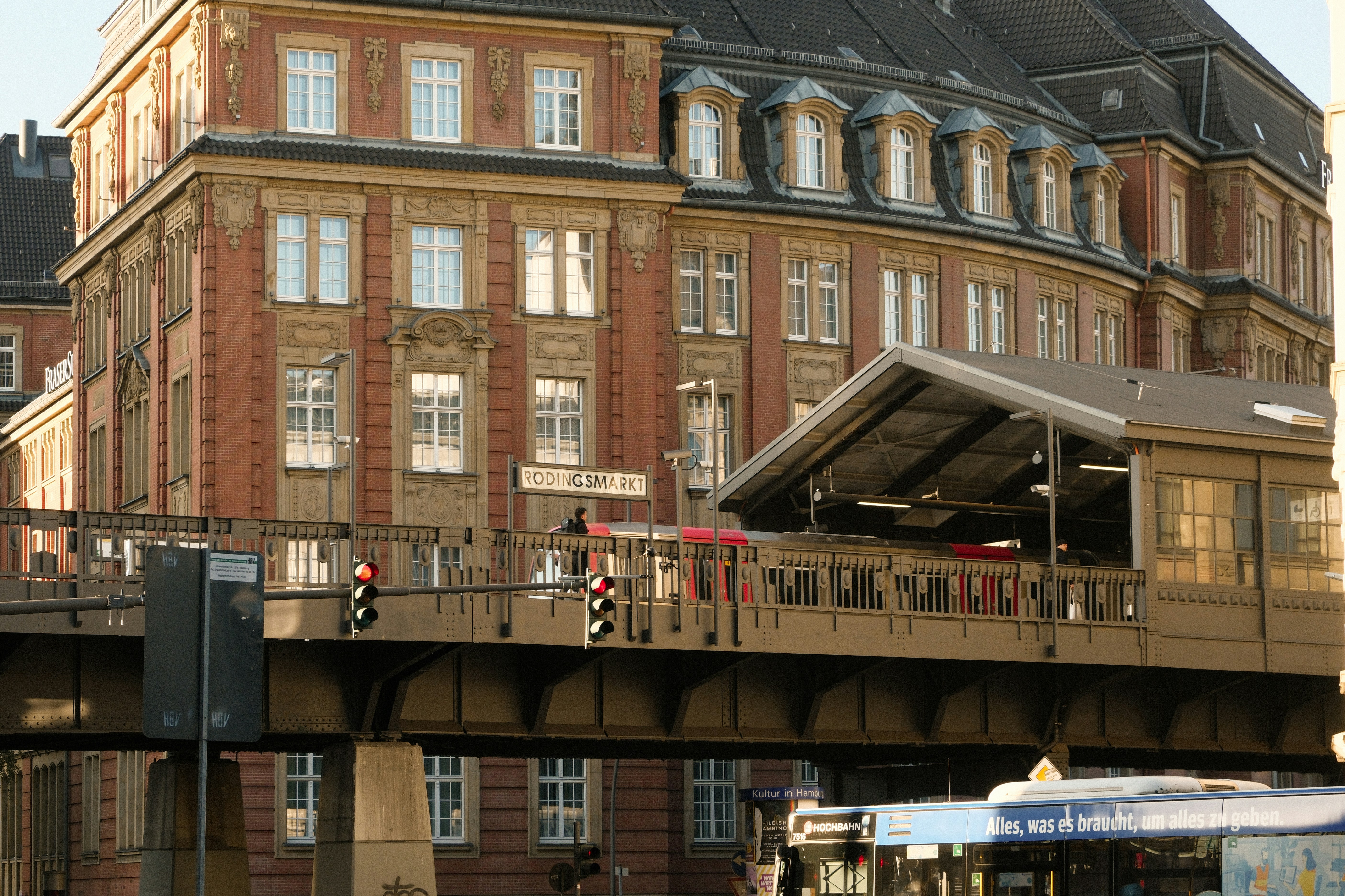 Brick Facade Above Rails: A Quiet City Crossing