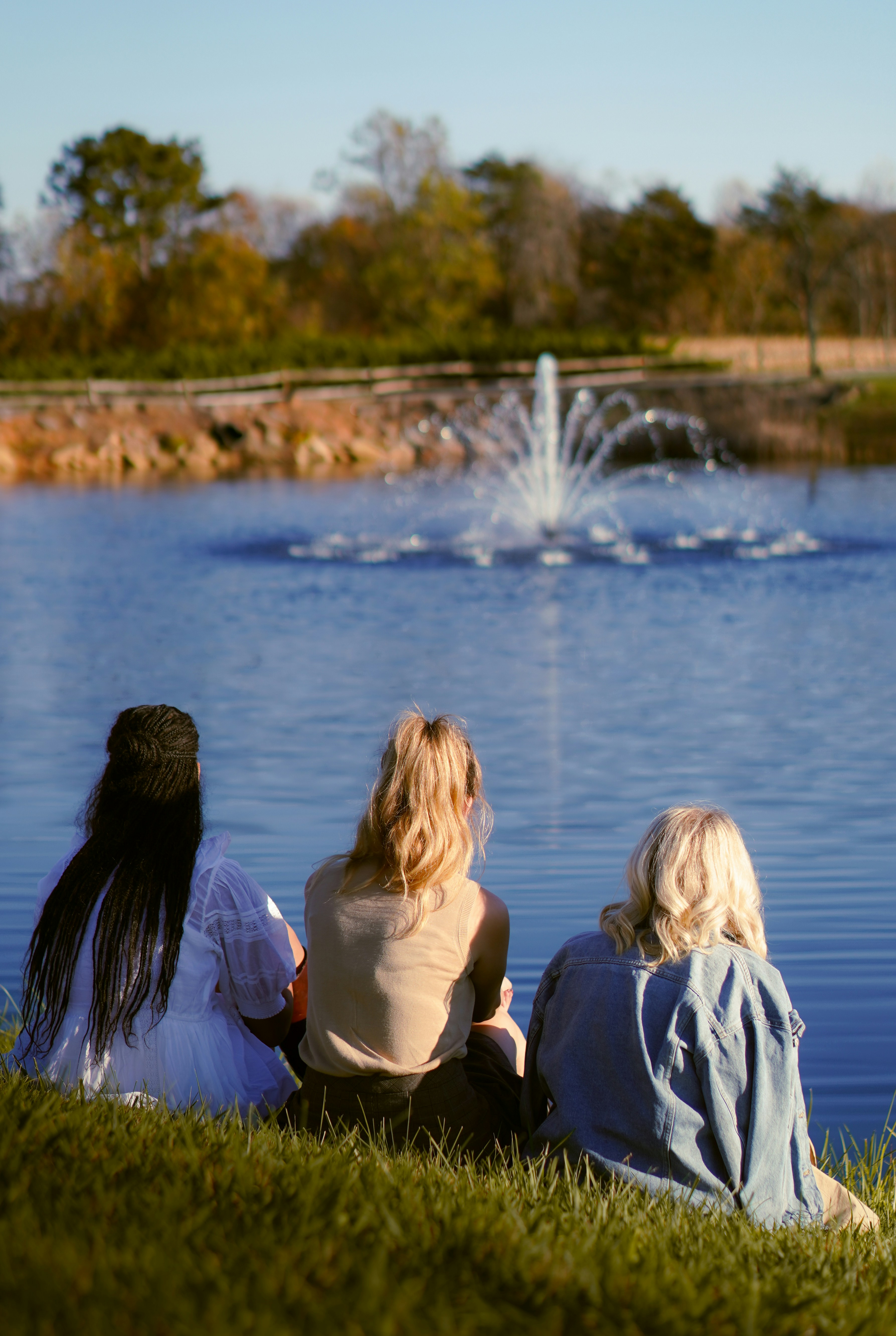 Three Friends by the Lake: A Soft-Focus Moment Centered on the Fountain