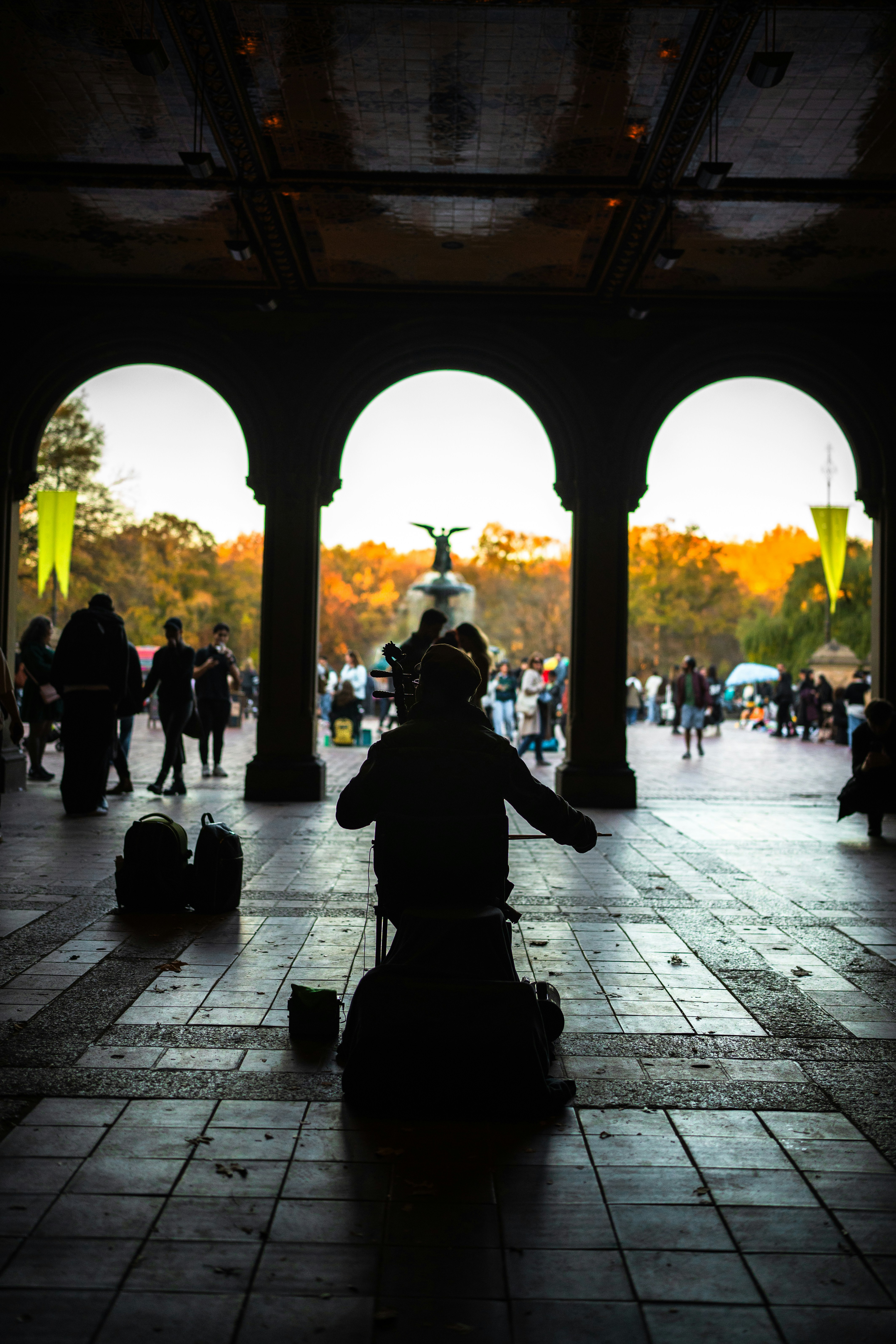 A person sitting on a chair in a room with arches photo – Free Central ...