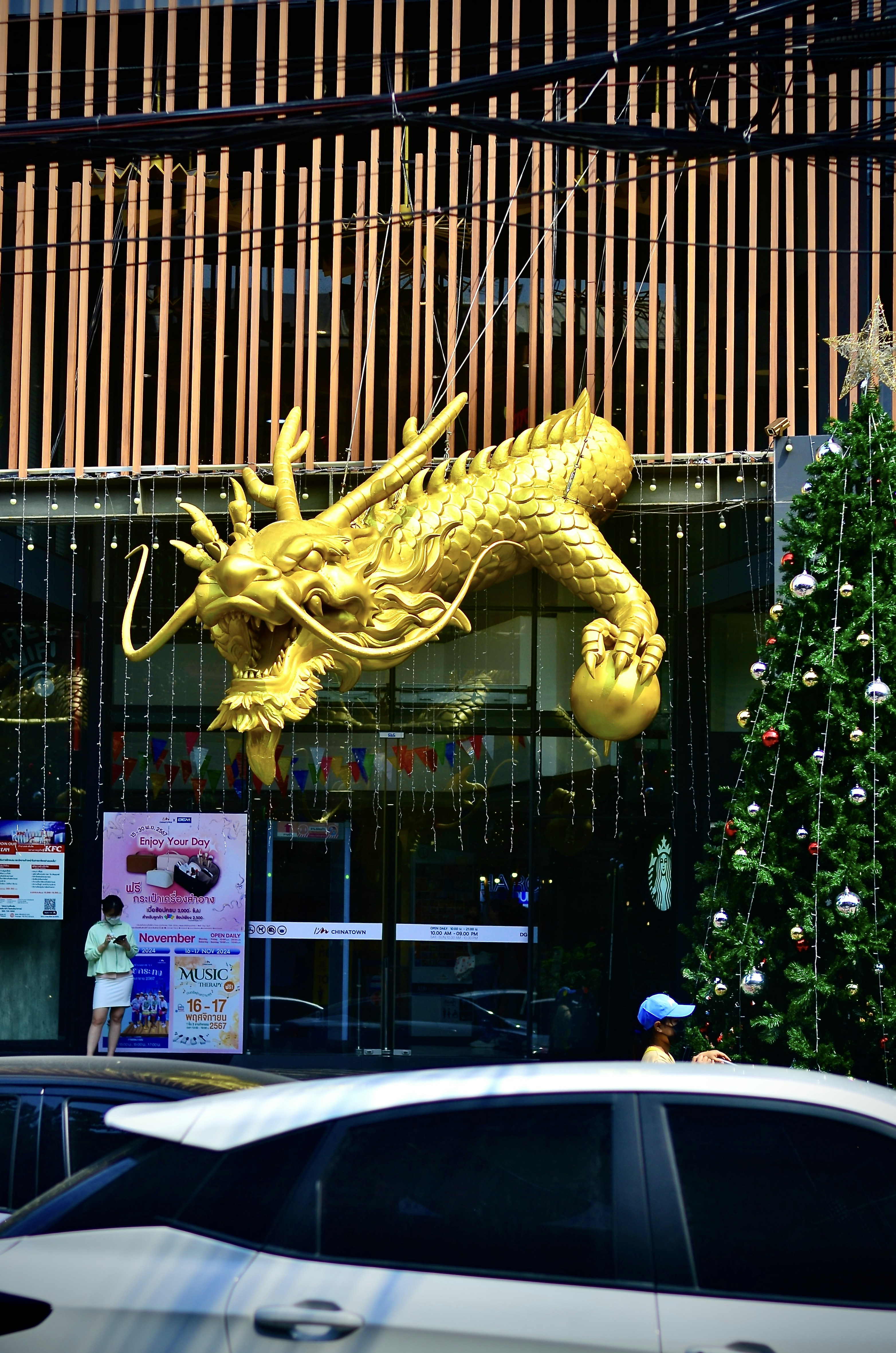 Golden Dragon Sculpture Stretches Over a Streetfront
