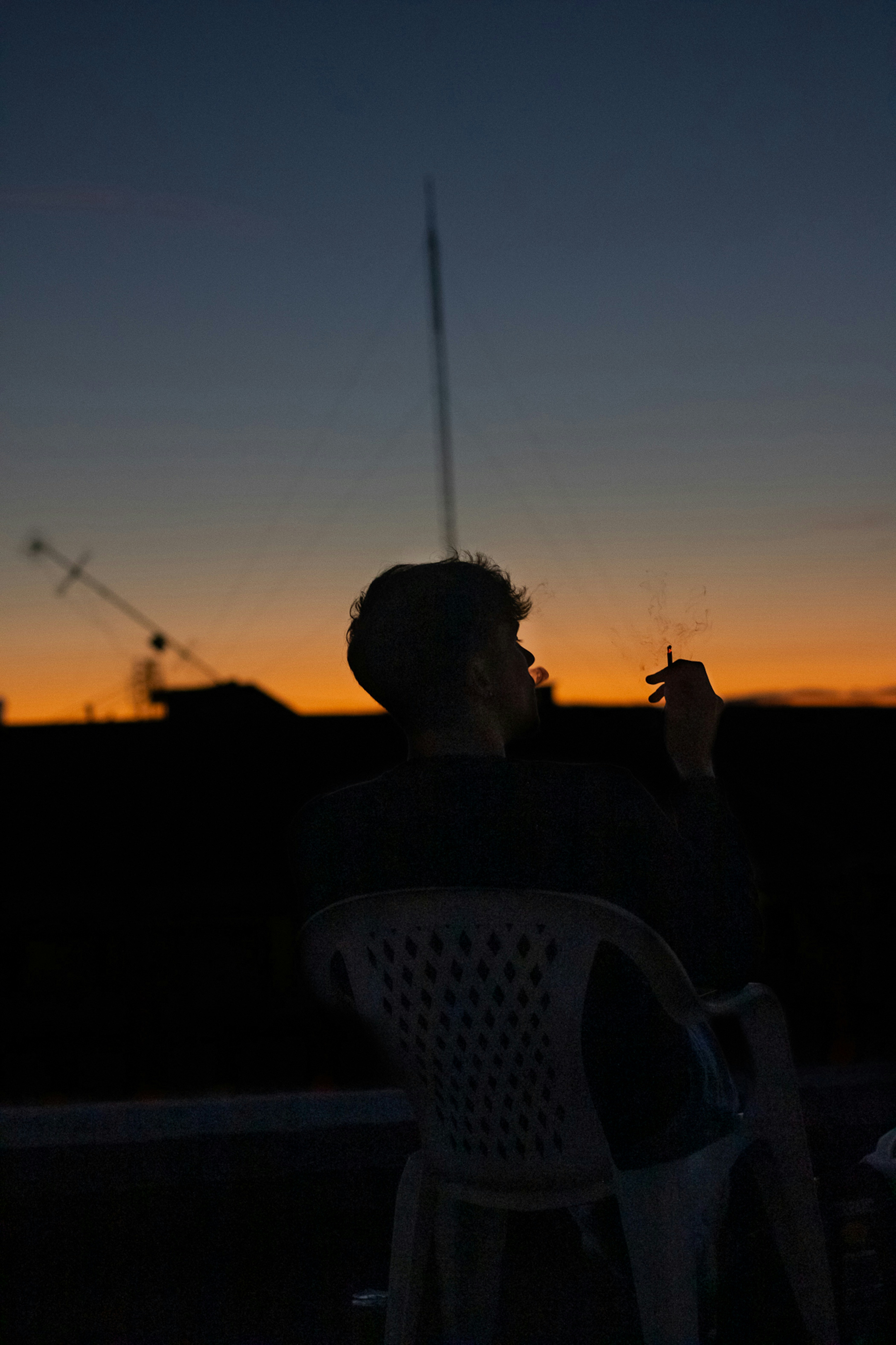 Dusk Silhouette on a Rooftop: A Quiet Moment Against the Horizon