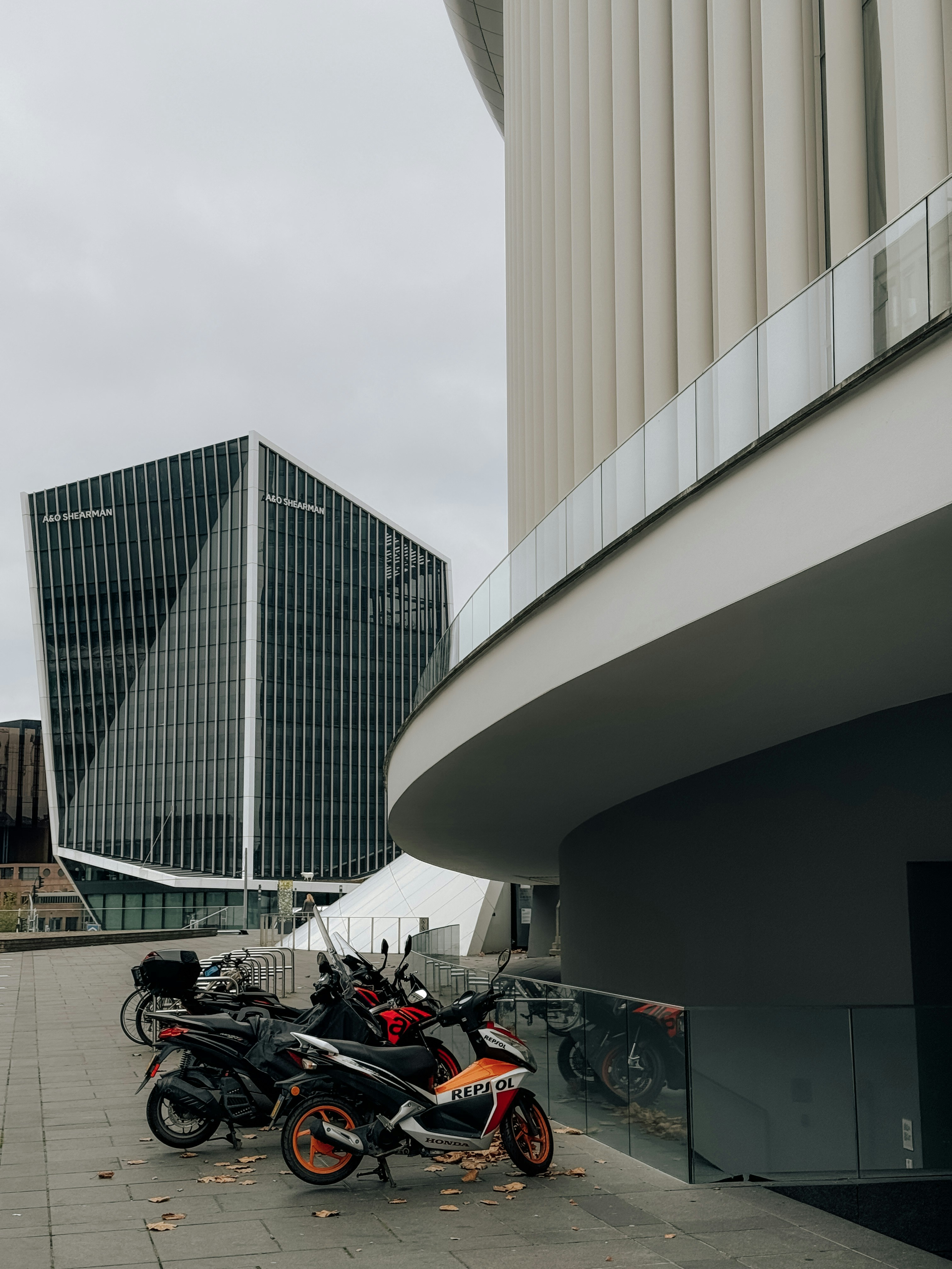 A group of motorcycles parked in front of a building photo – Free ...