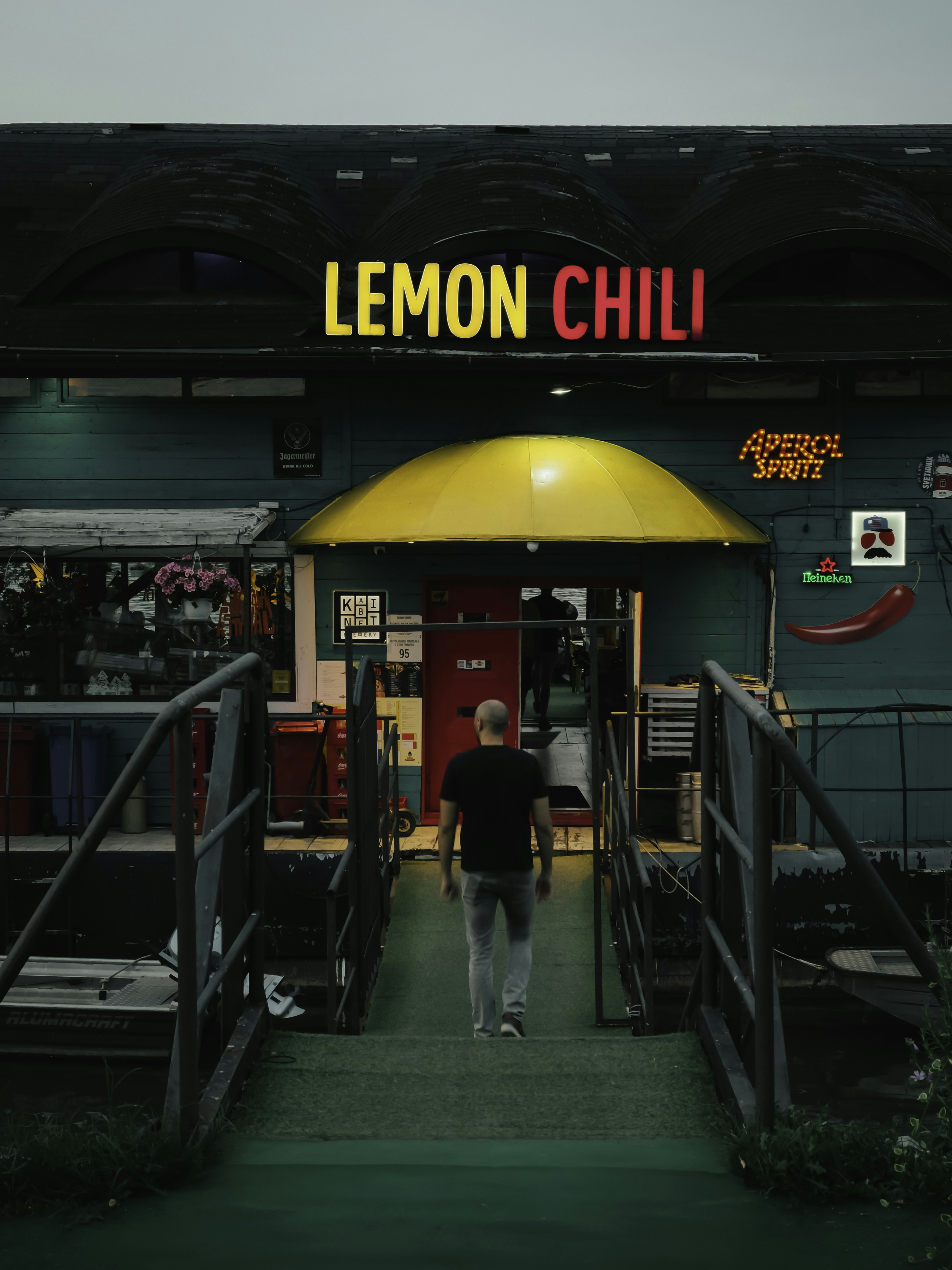 A man walking down a ramp into a restaurant photo – Free Man Image on ...