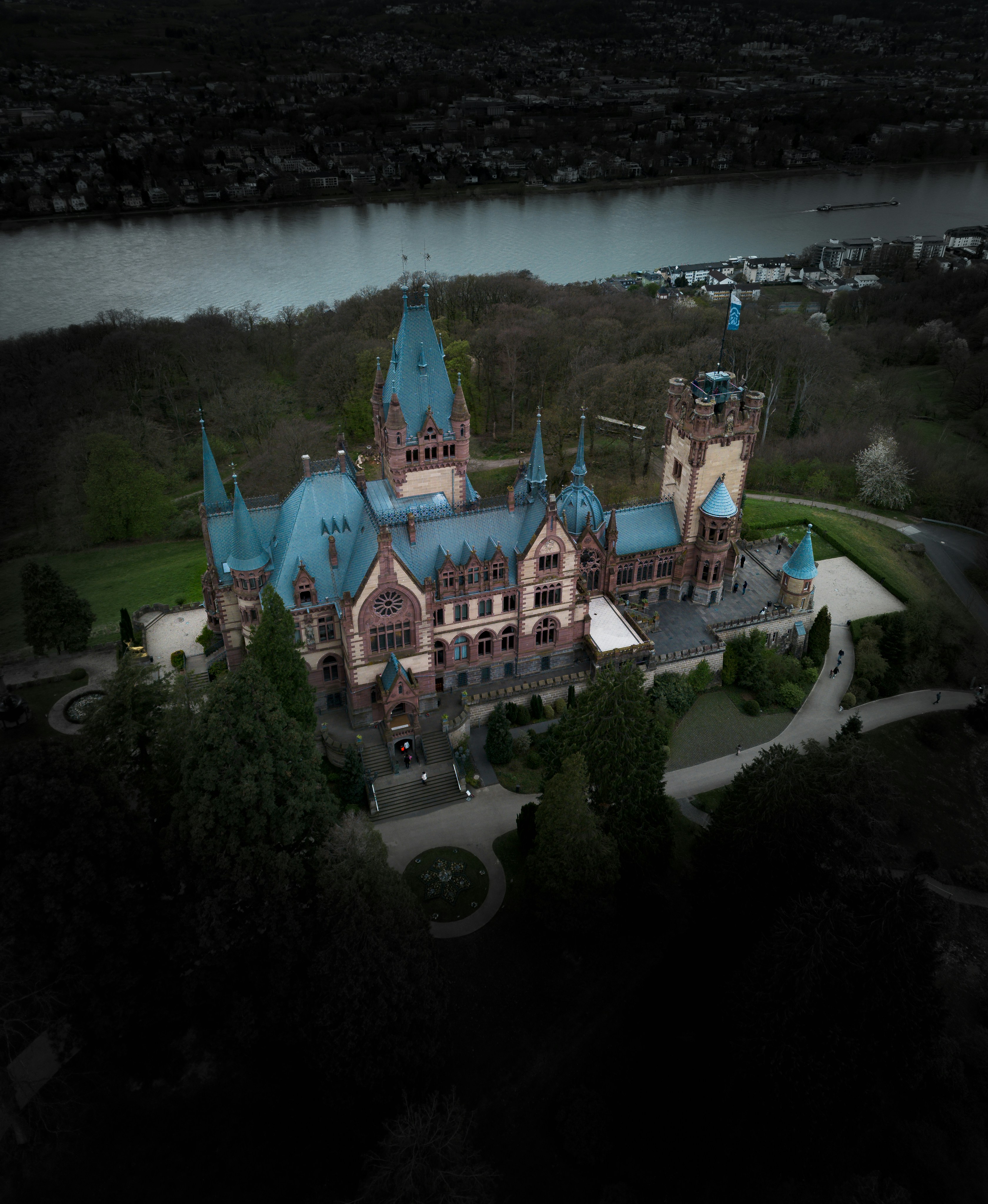 Blue-Tiled Castle at Dusk: Aerial Portrait Over the River Bend
