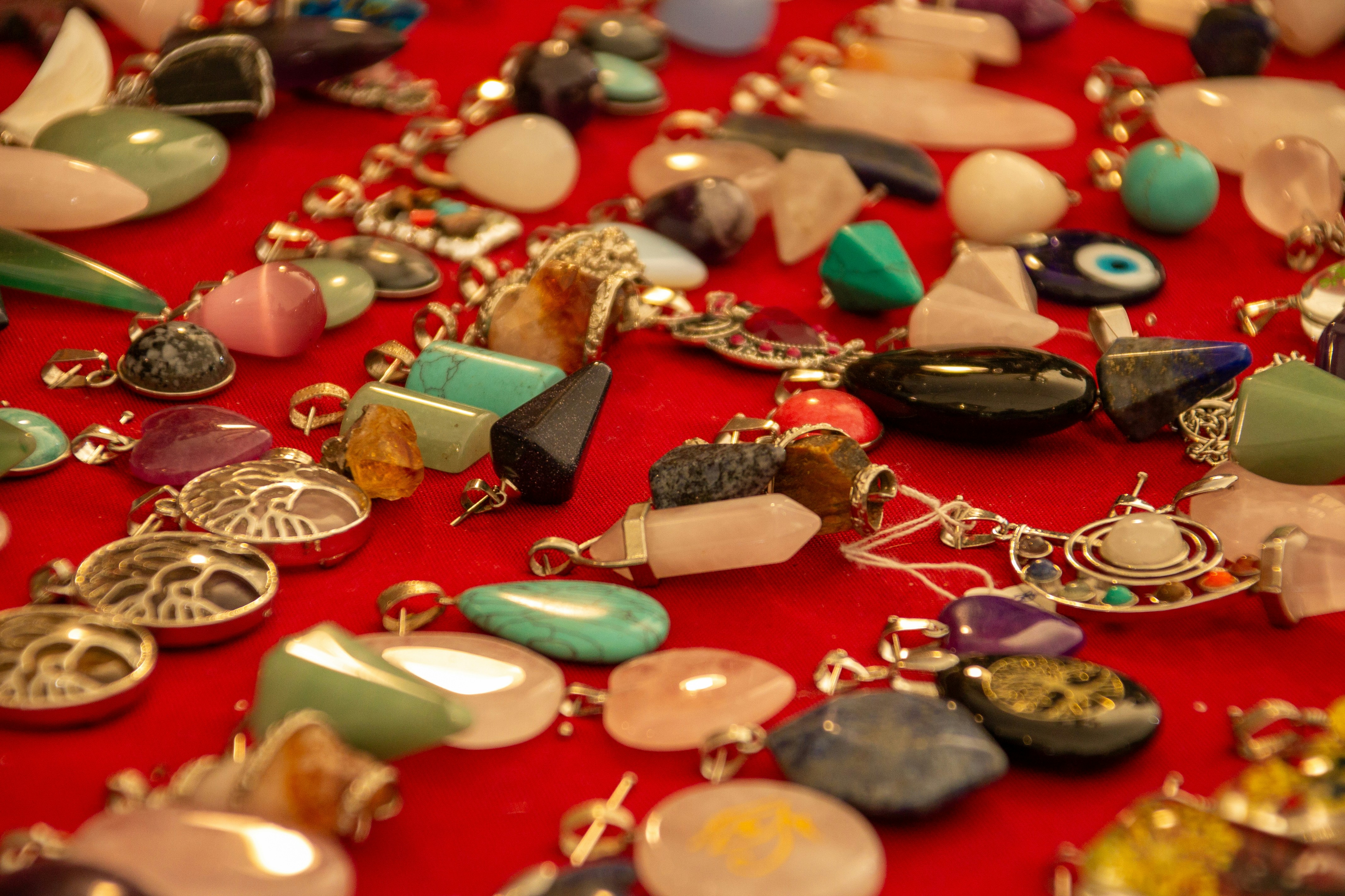 A table topped with lots of different types of necklaces photo – Free ...