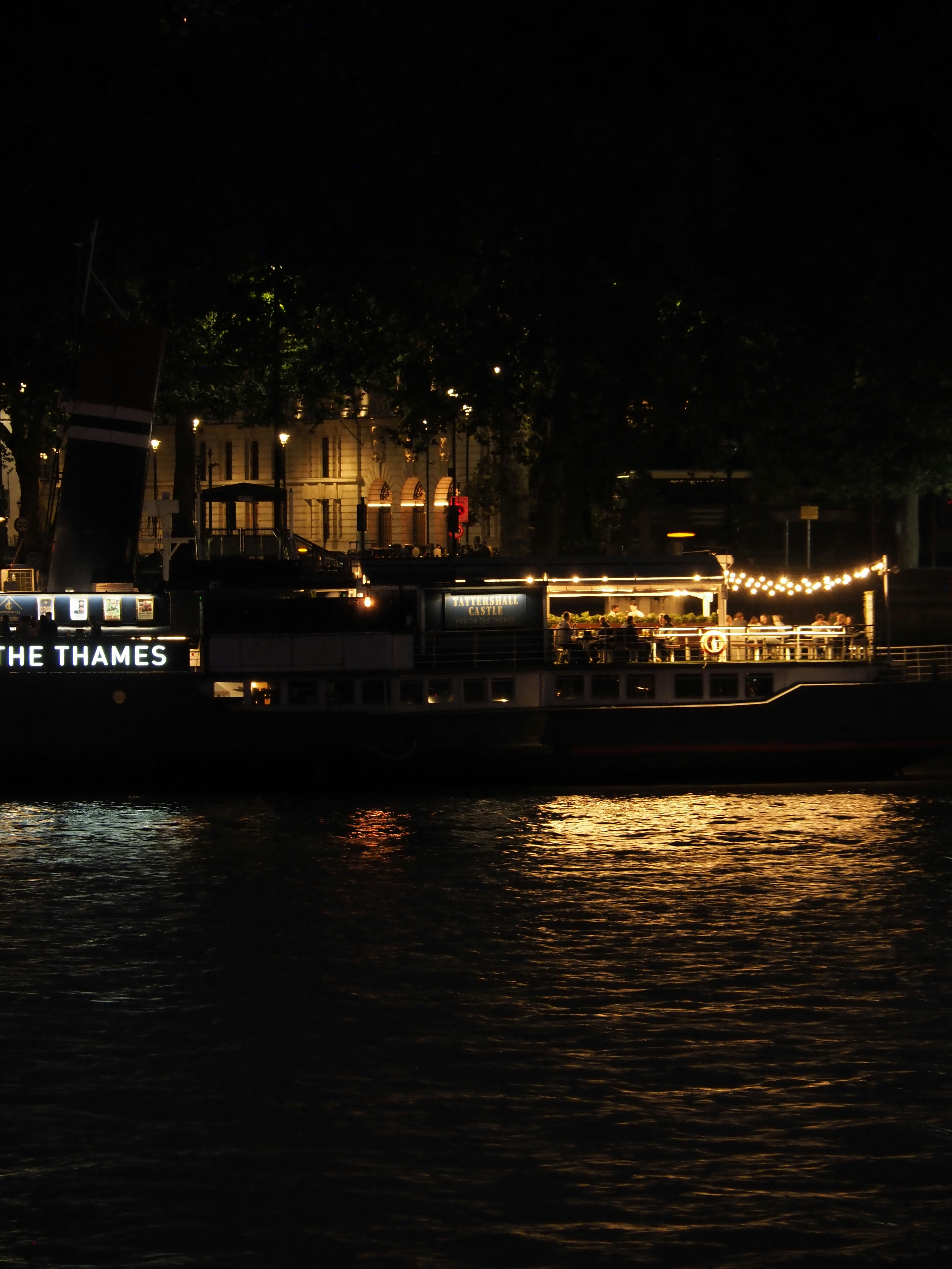 Thames at Night: Lantern-Lit Paddle Steamer Skims Across Reflections