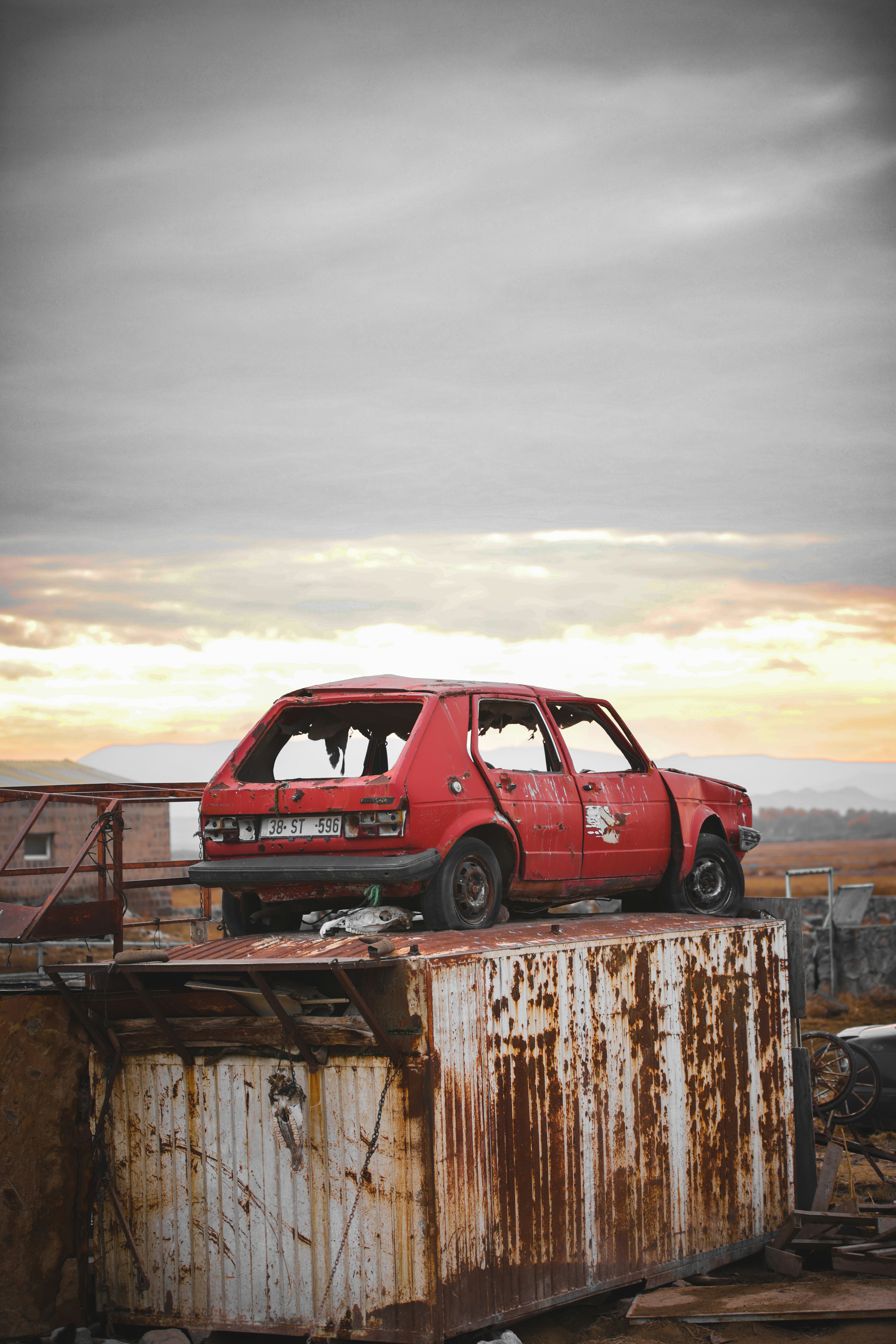 A red car sitting on top of a rusty box photo – Free Machine Image on ...
