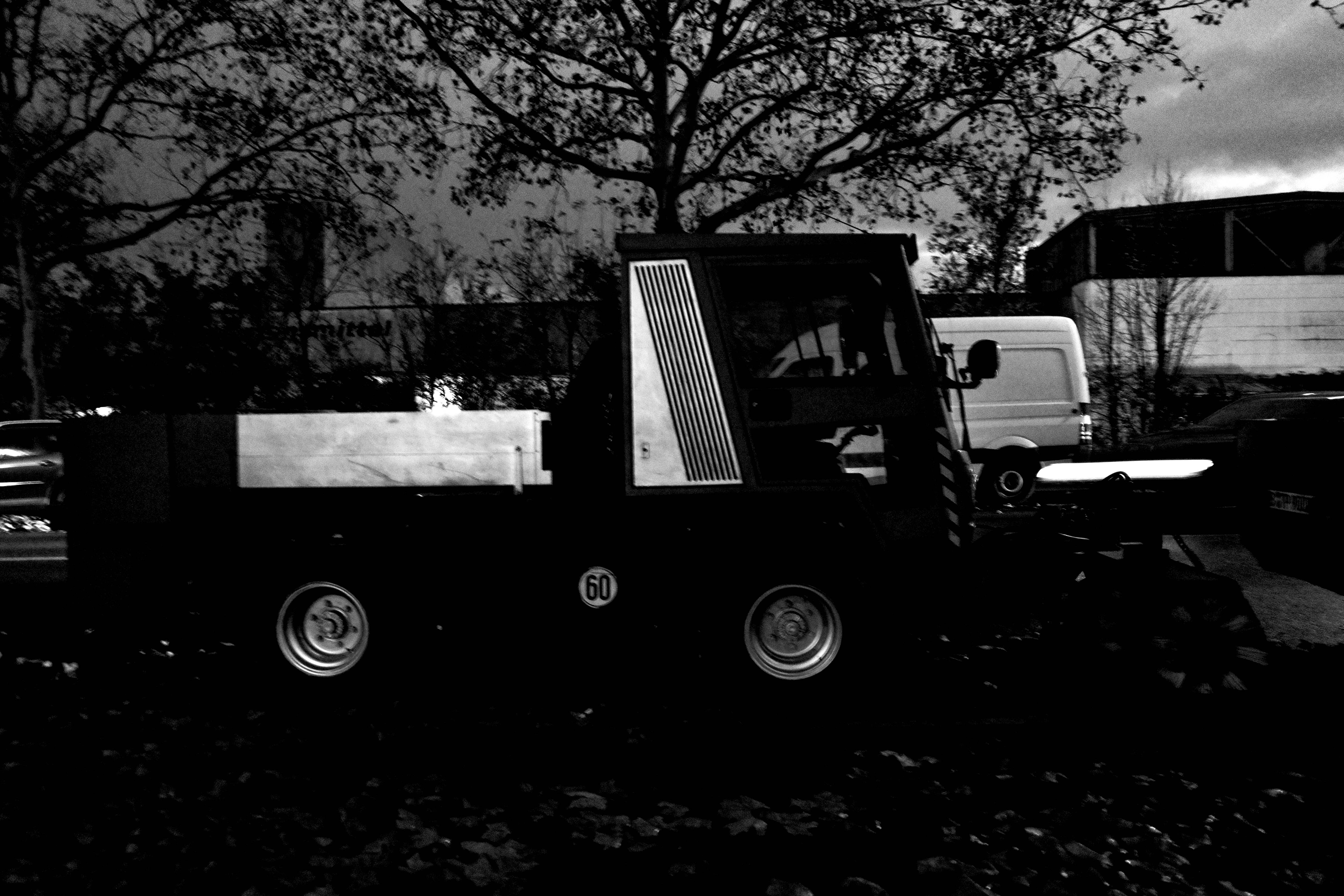 Dim Yard Sentinel: A Silhouetted Industrial Vehicle